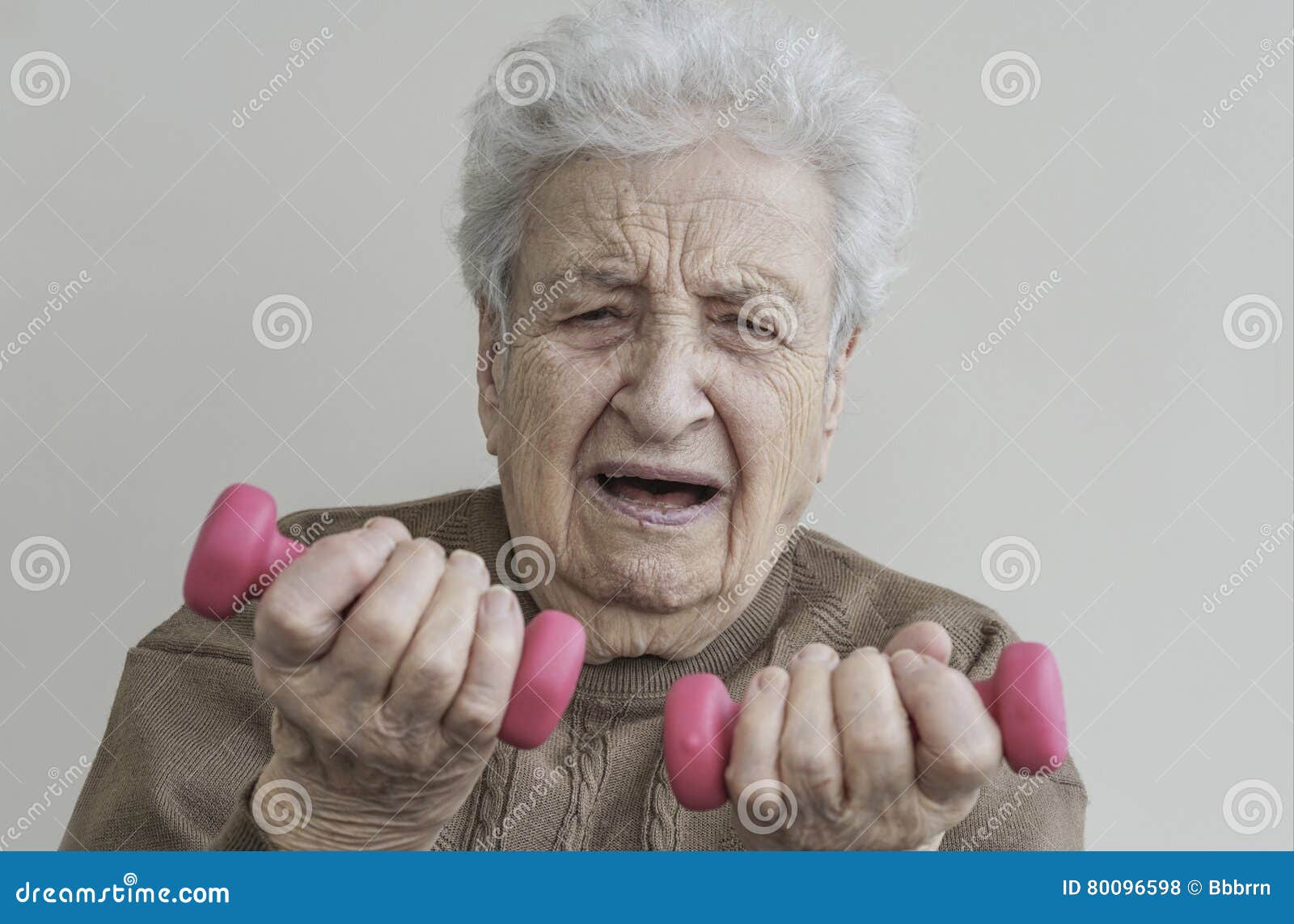 Senior Woman is Difficultly Lifting the Dumbbells Stock Photo - Image ...