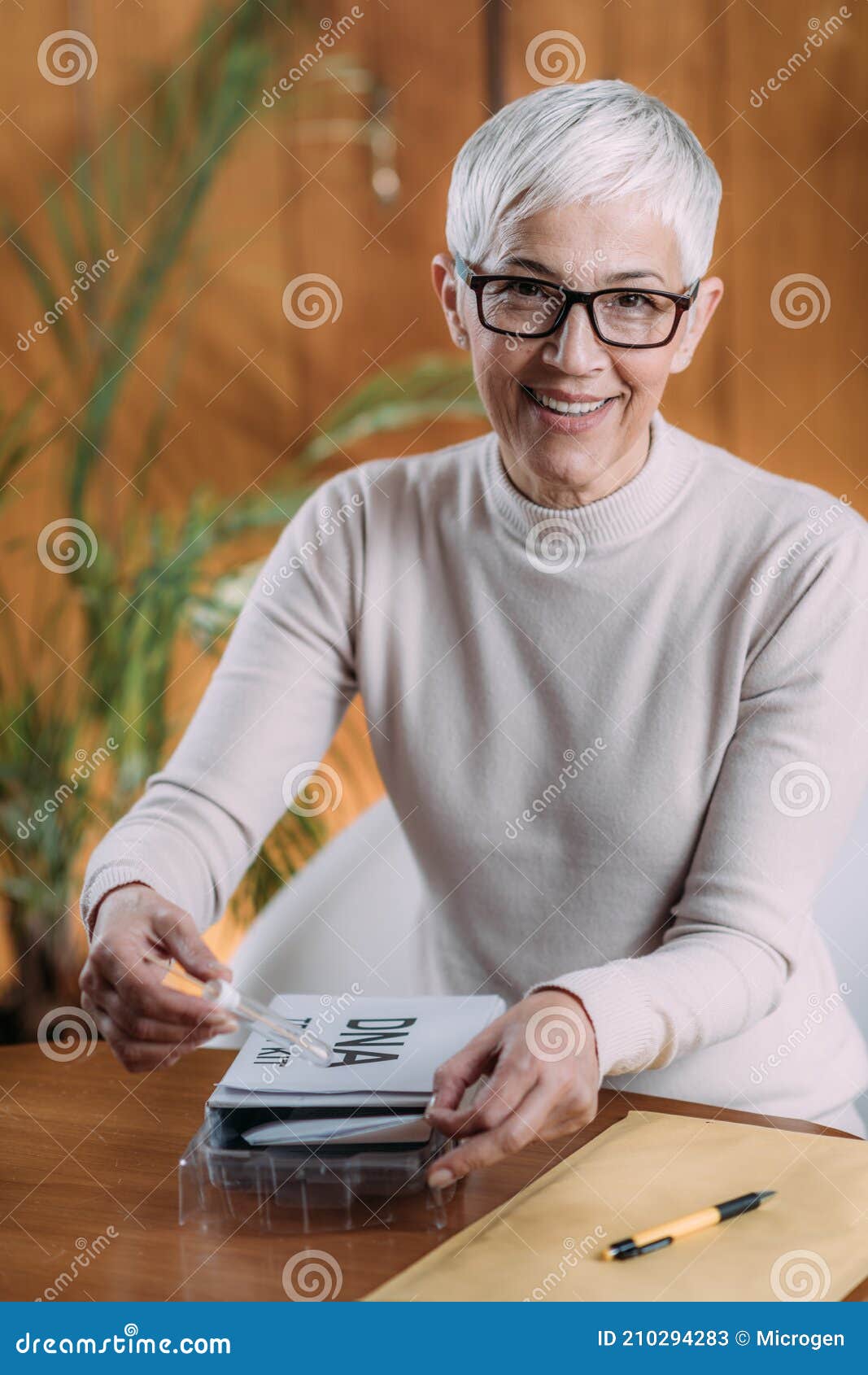 Senior Woman Doing a Mailed DNA Test at Home Stock Image - Image of ...