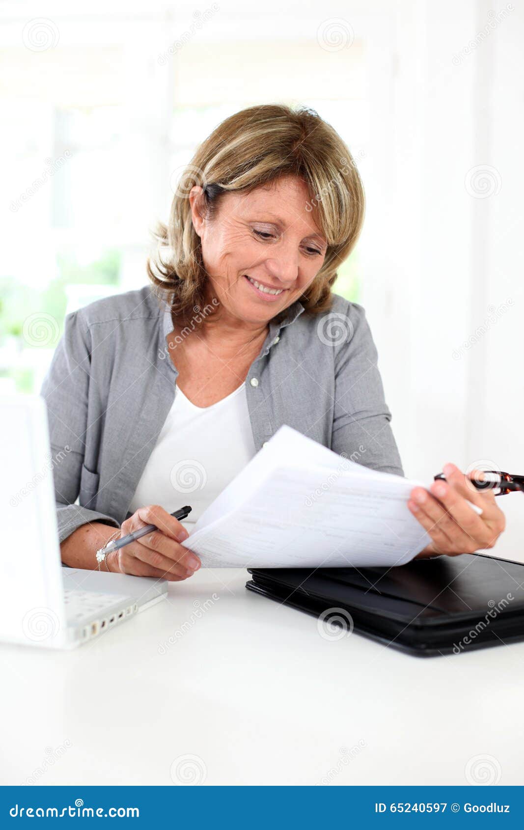 Senior Woman Doing Paperwork with Help of Internet Stock Image - Image ...