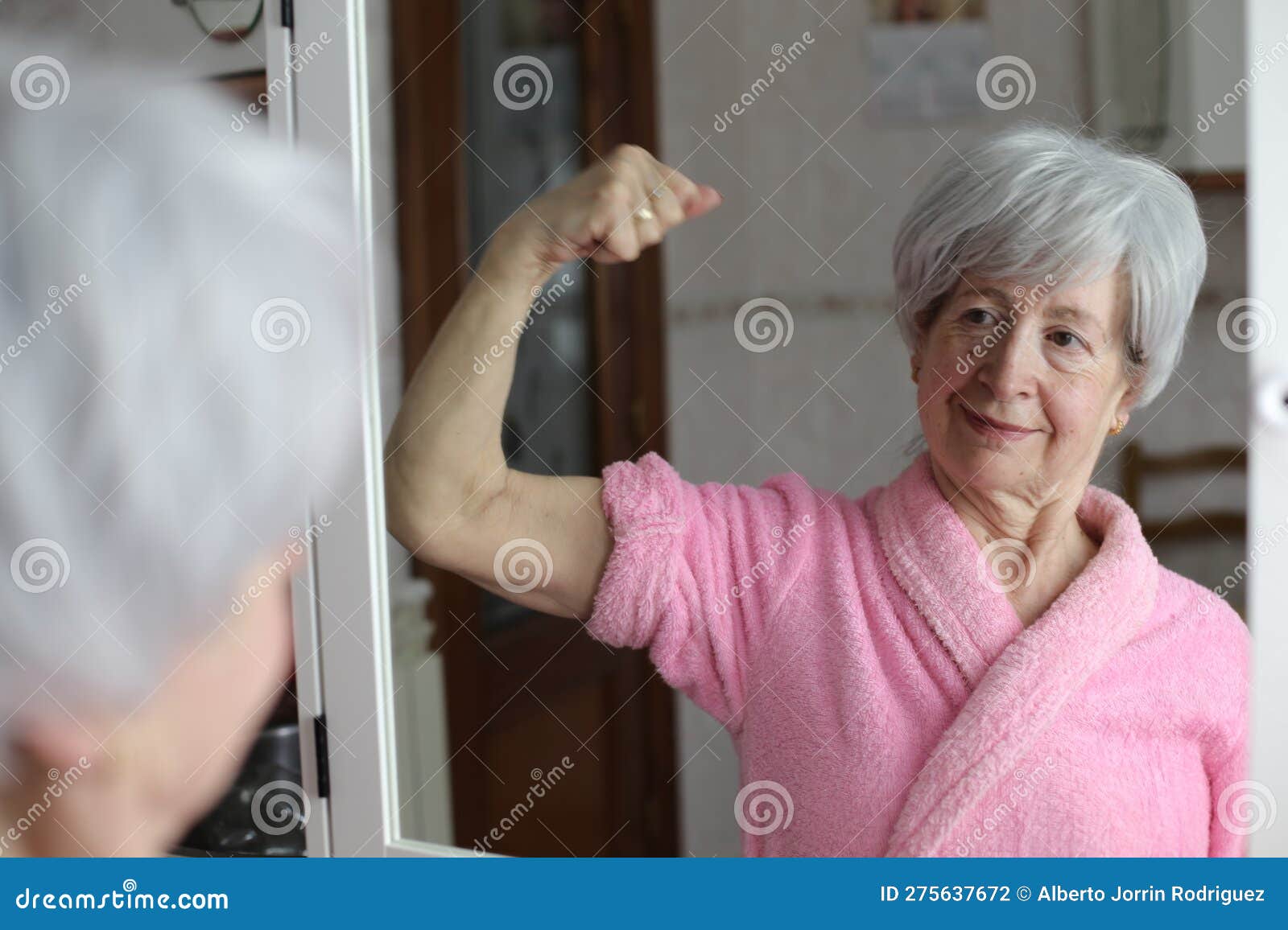 Senior Woman Flexing Biceps in the Mirror Stock Photo - Image of ...