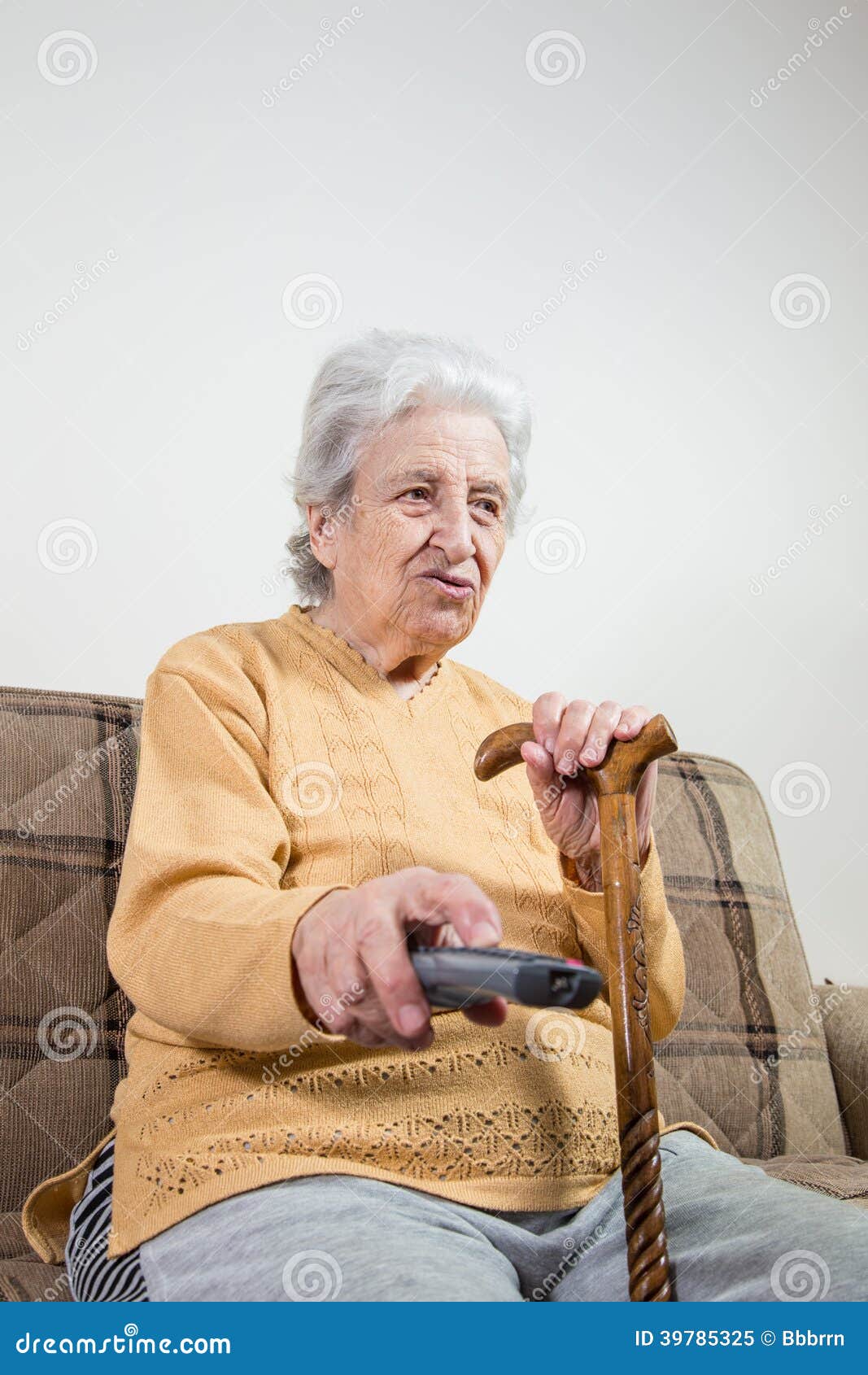 A Senior Woman Holding (using) Remote Control Stock Image - Image of ...