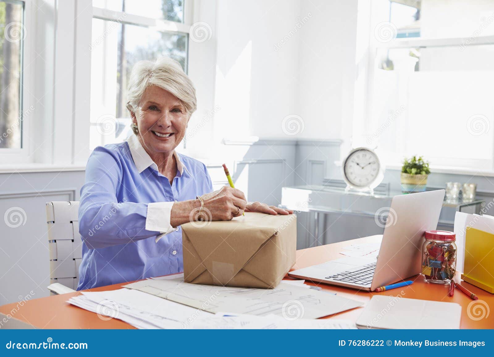 Senior Woman at Home Addressing Package for Mailing Stock Photo - Image ...