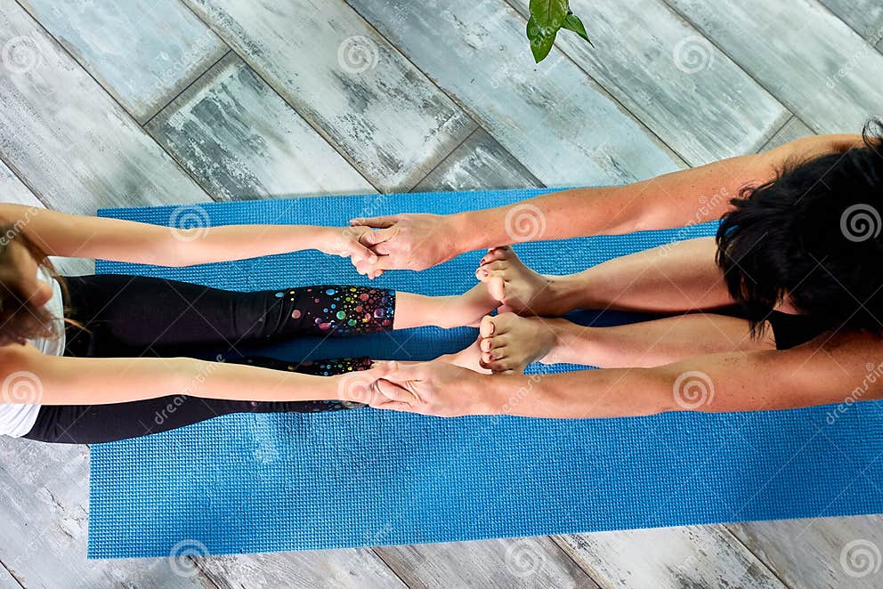 Mother Or Grandmother And Her Daughter Doing Gymnastic Together At Home