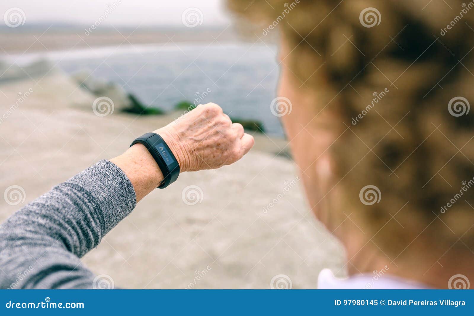 Senior Woman Looking Smart Watch Stock Image - Image of female, aged ...