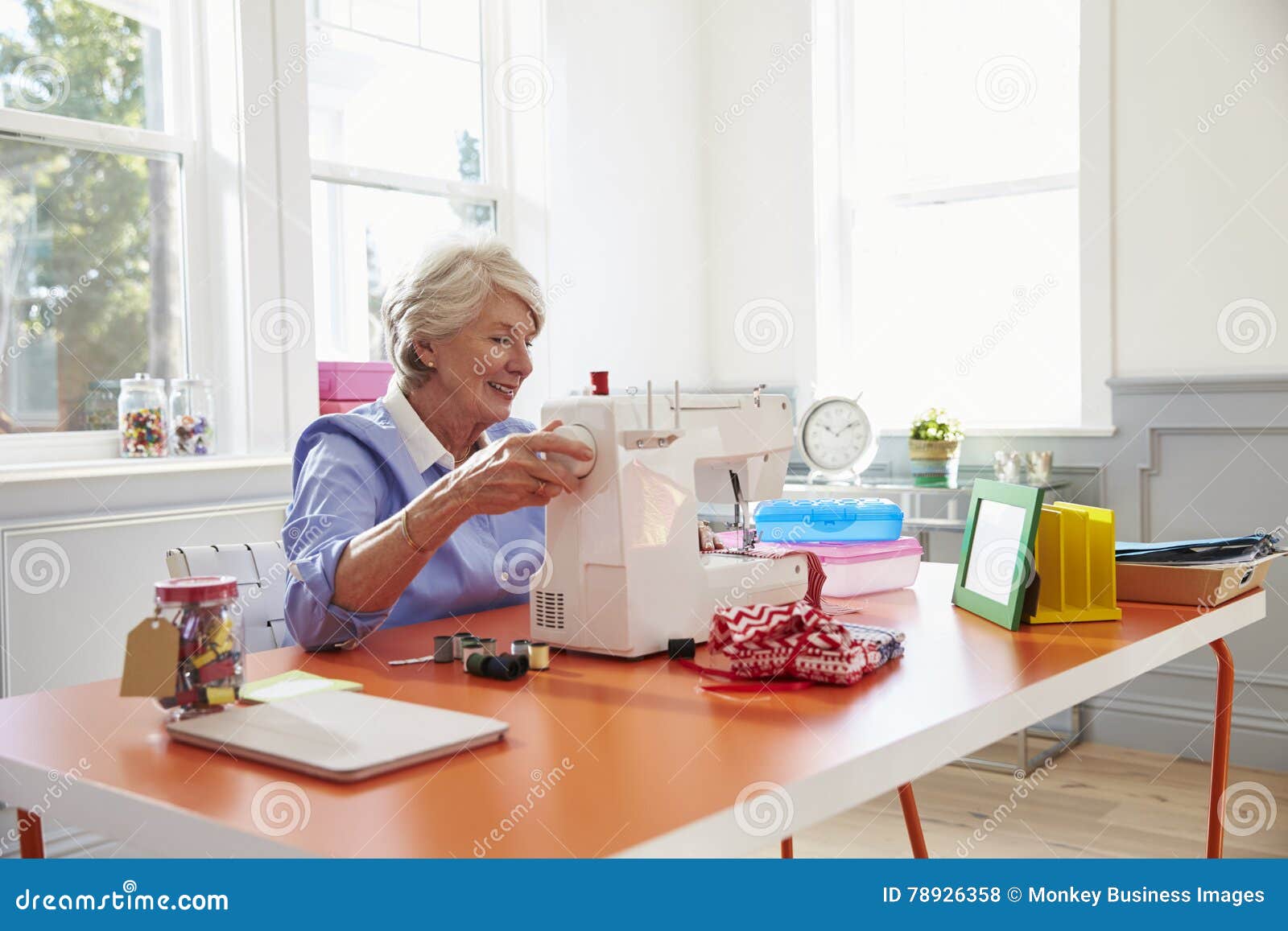 Senior Woman Making Clothes Using Sewing Machine at Home Stock Photo ...