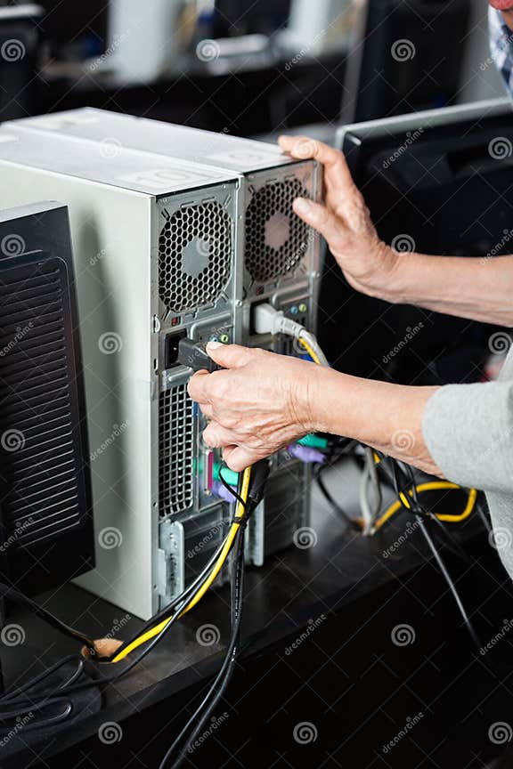 Senior Woman Plugging Computer in Classroom Stock Image - Image of hand ...