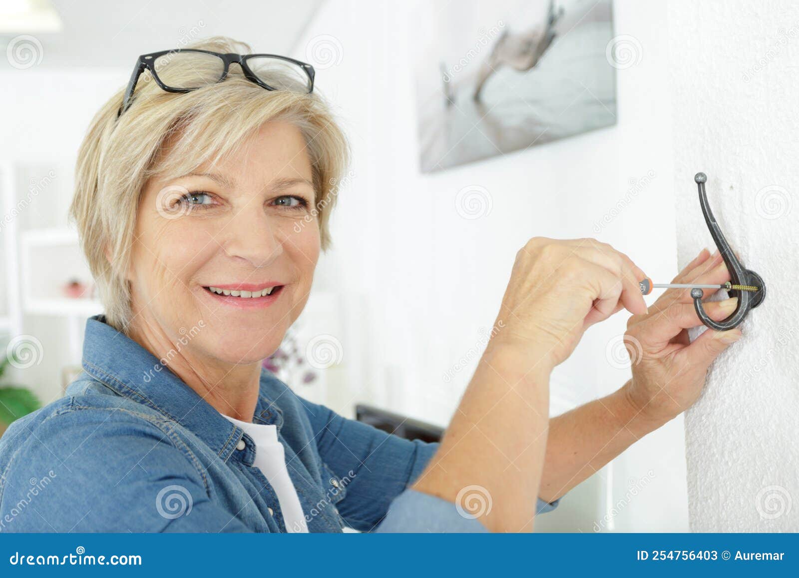 Senior Woman Putting Hook on Wall Stock Image - Image of attorney ...