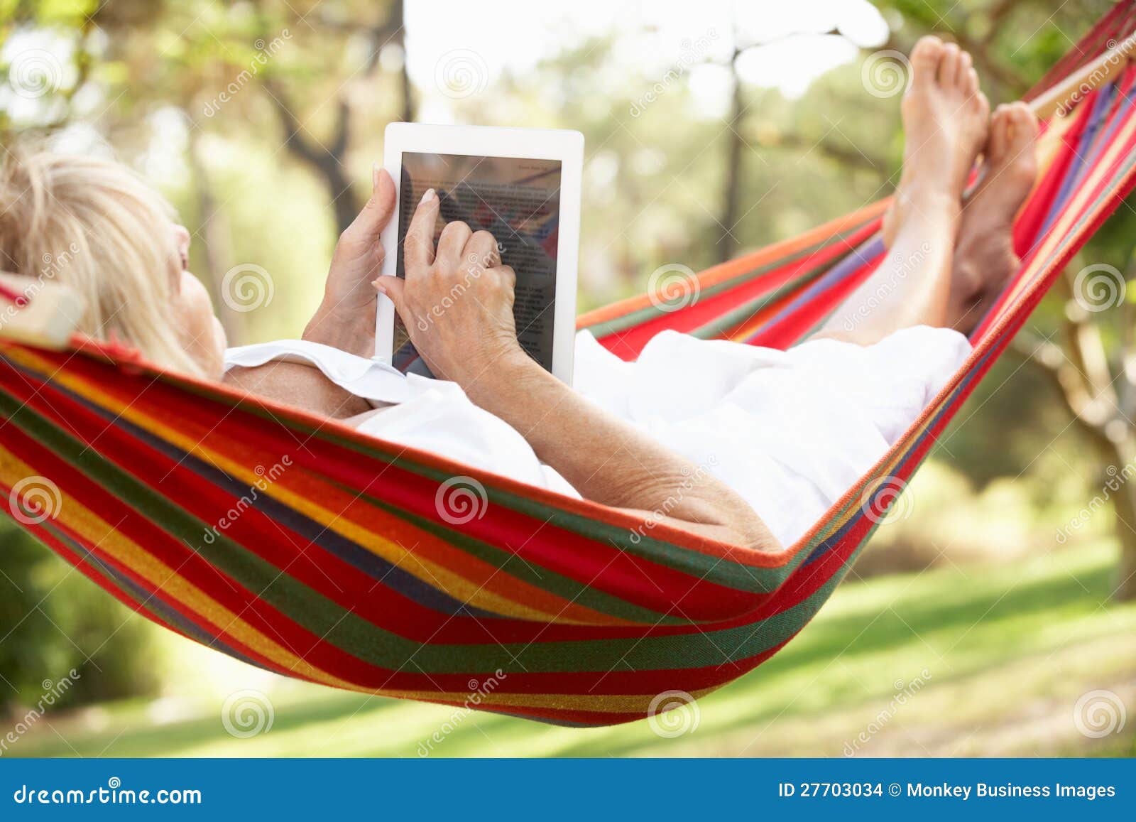 Senior Woman Relaxing in Hammock with E-Book Stock Photo - Image of ... Senior Woman Relaxing in Hammock with E-Book Stock Photo - Image of ...
