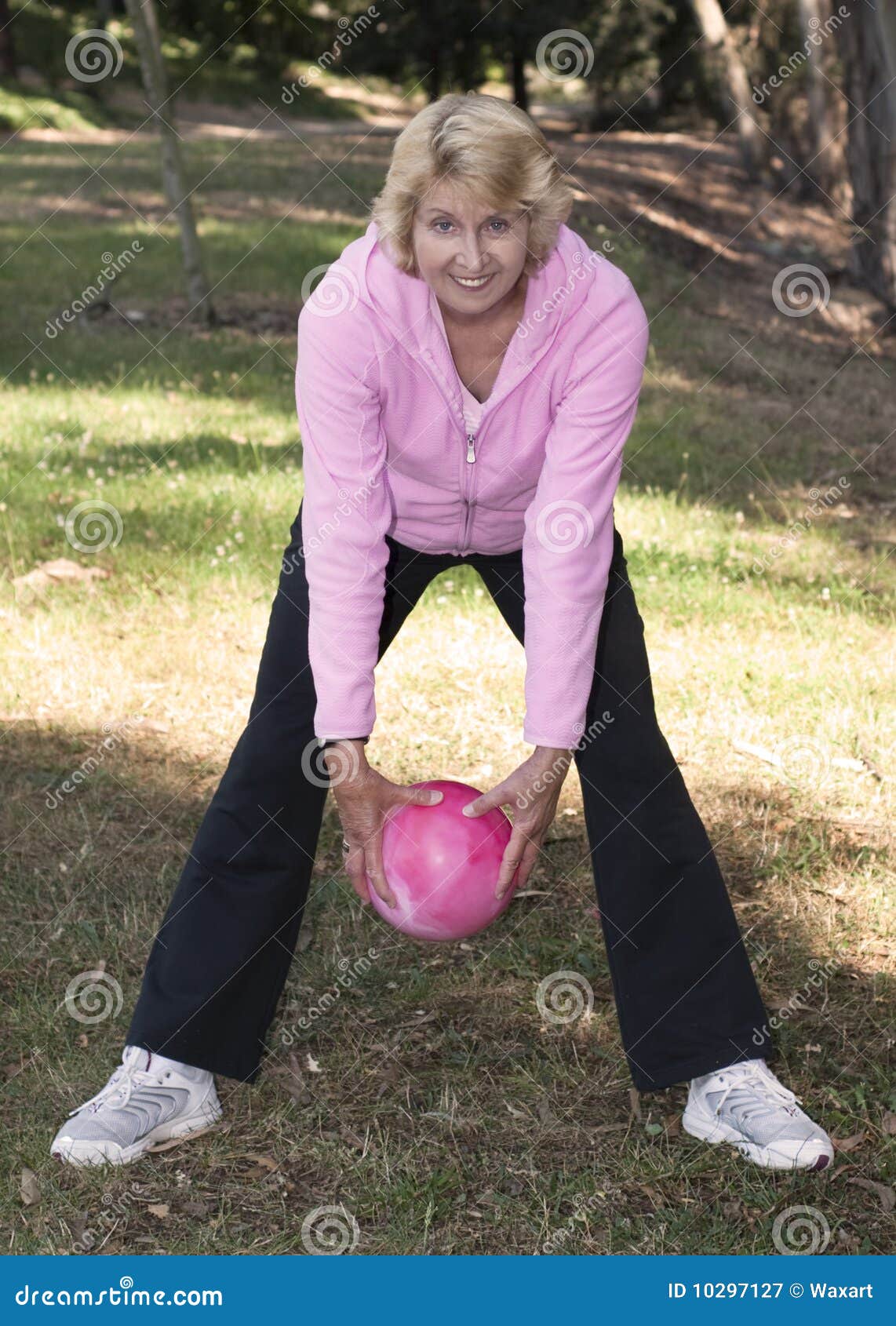 Senior Woman Rolling Ball in Park Stock Image - Image of smiling, full ...