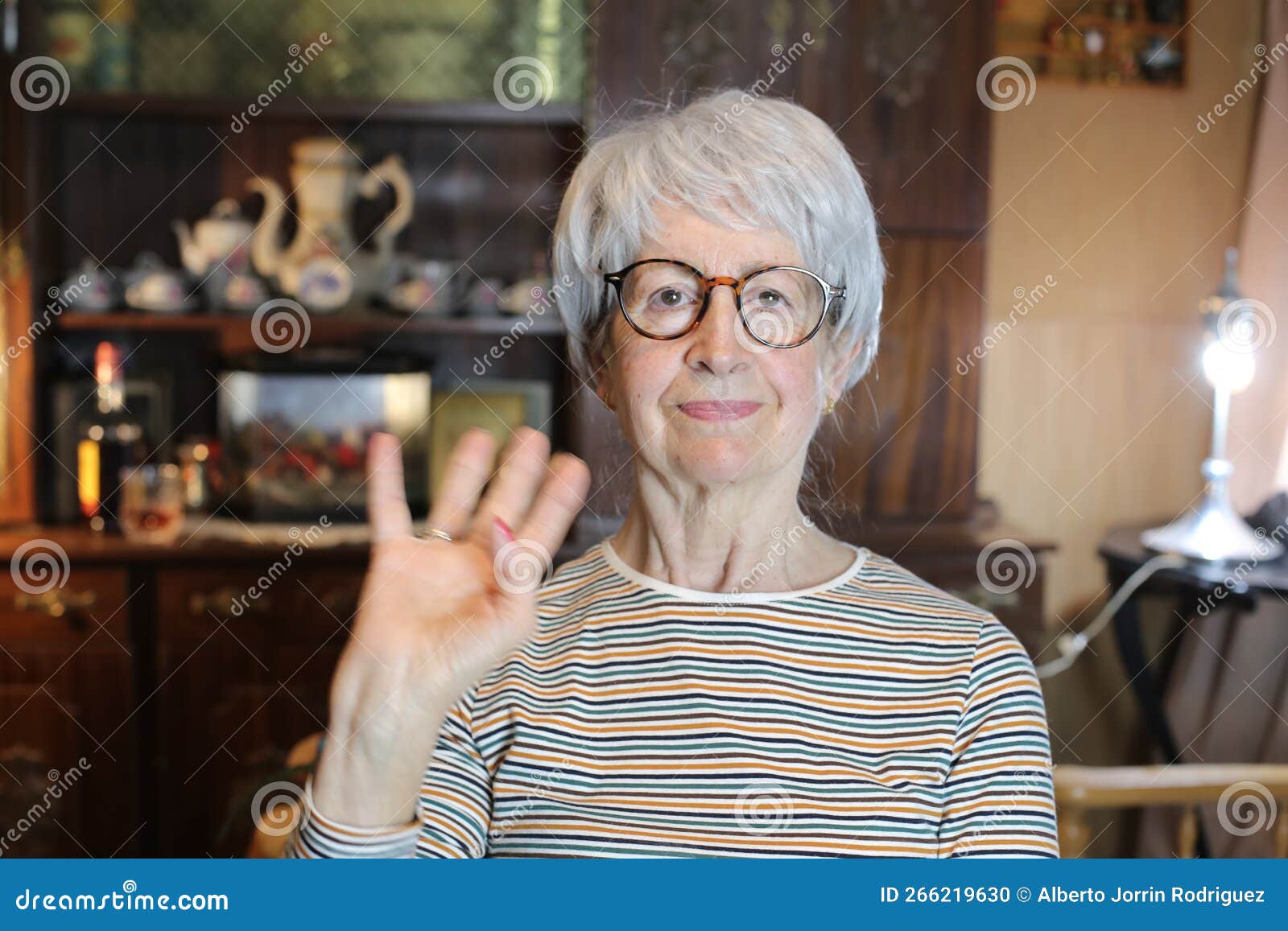 Senior Woman Saluting with Hand Gesture Stock Photo - Image of ...