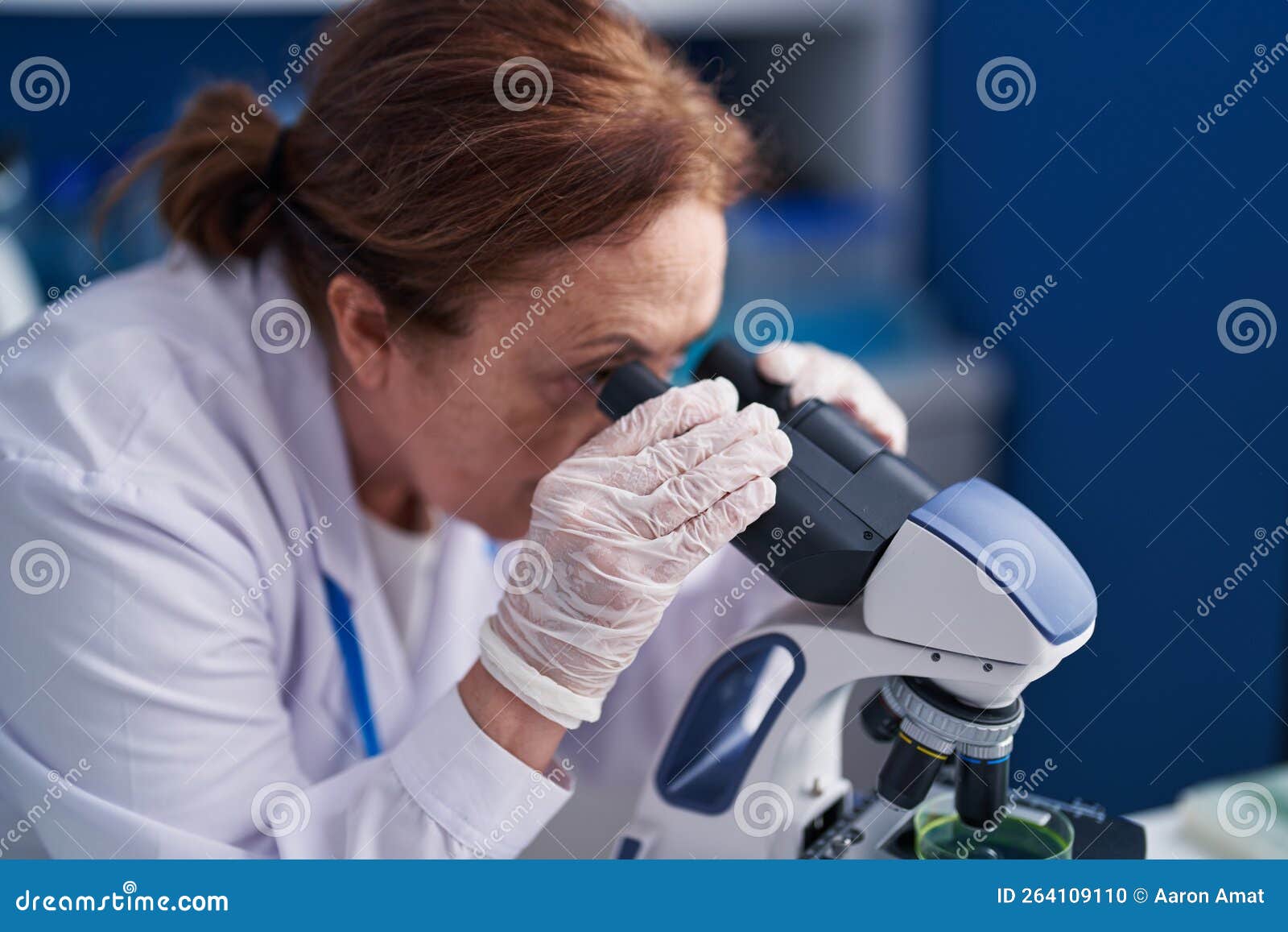 Senior Woman Scientist Using Microscope at Laboratory Stock Photo ...