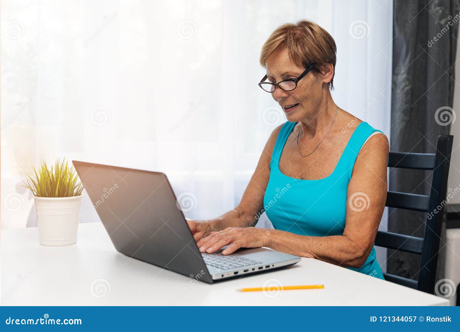 Senior Woman Using Laptop Computer at Home Stock Image - Image of room ...