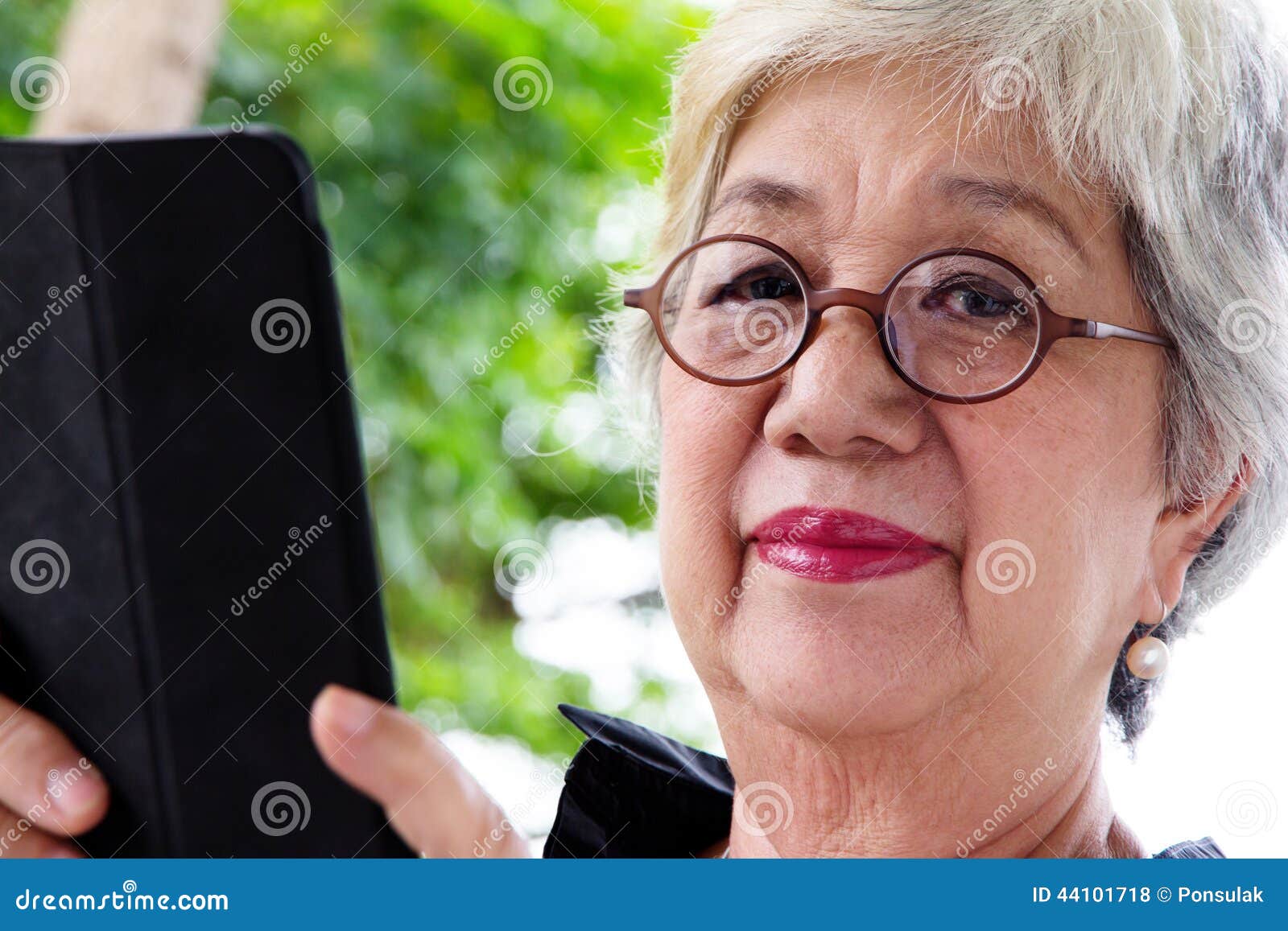 Senior woman with tablet stock photo. Image of listening - 44101718