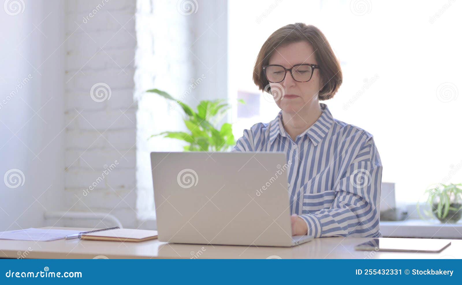 Senior Woman Thinking while Working on Laptop Stock Image - Image of ...