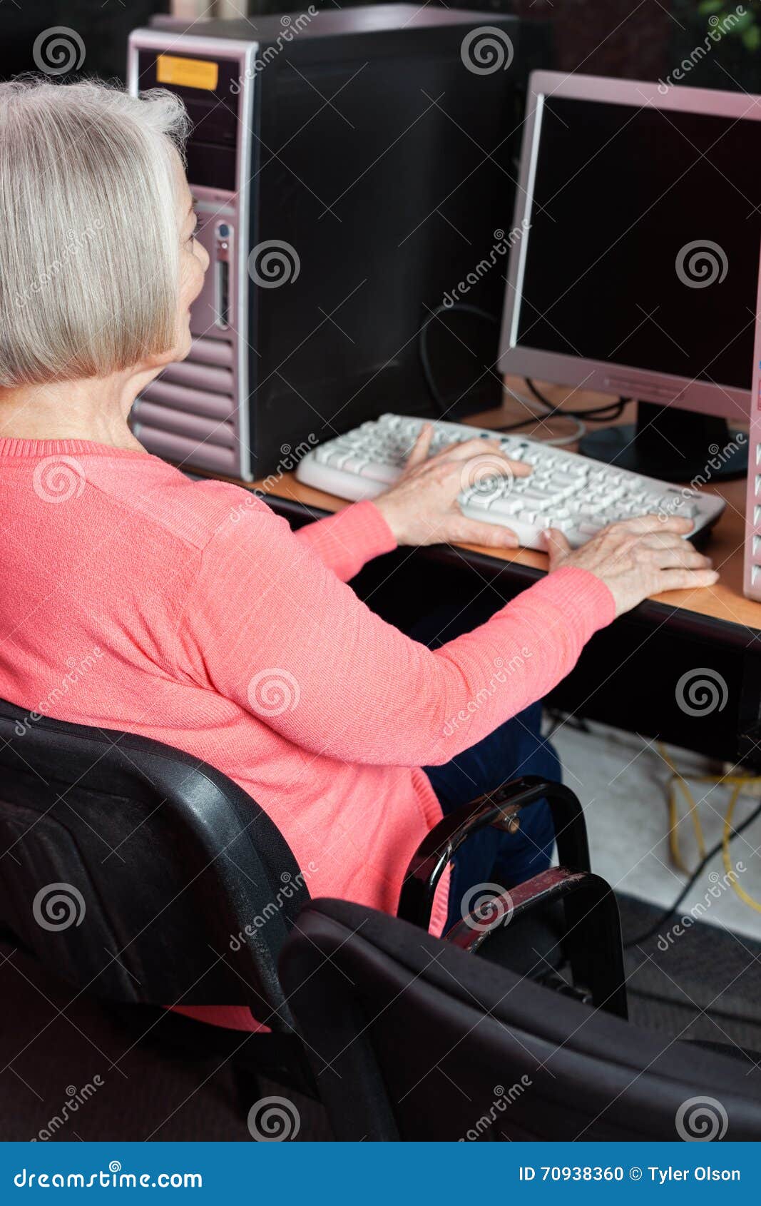 Senior Woman Using Computer at Desk in Classroom Stock Photo - Image of ...