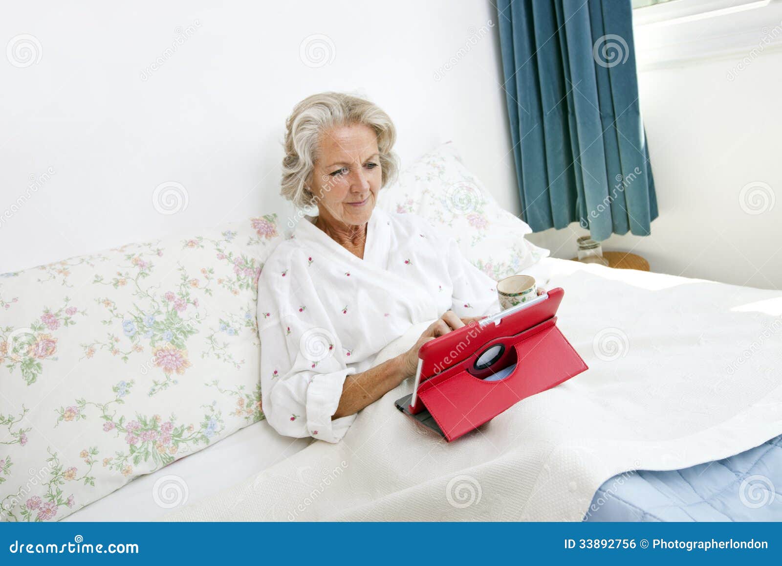 Senior Woman Using Digital Tablet on Bed at Home Stock Photo - Image of ...