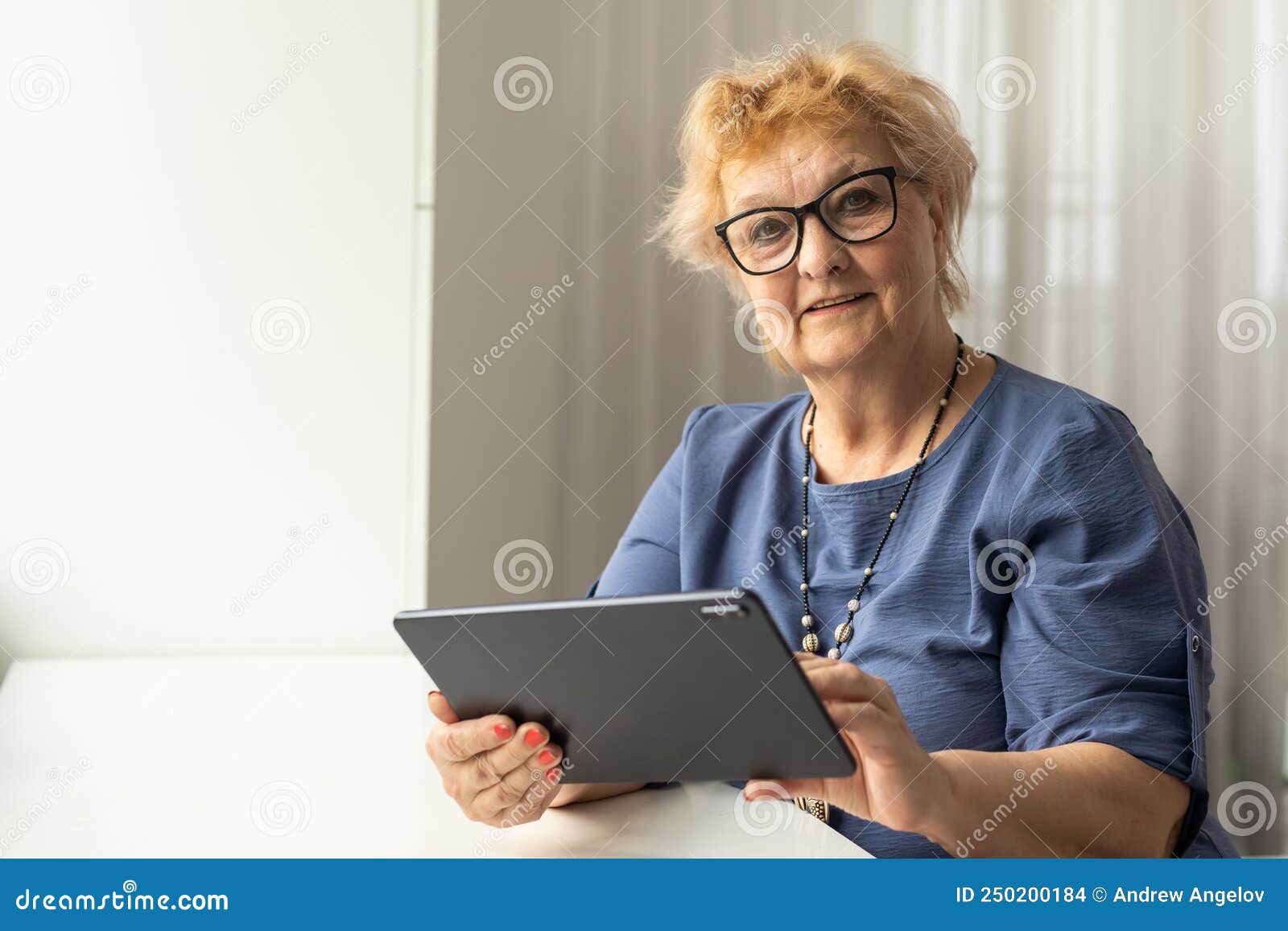 Senior Woman Using Digital Tablet at Home. the Use of Technology by the ...