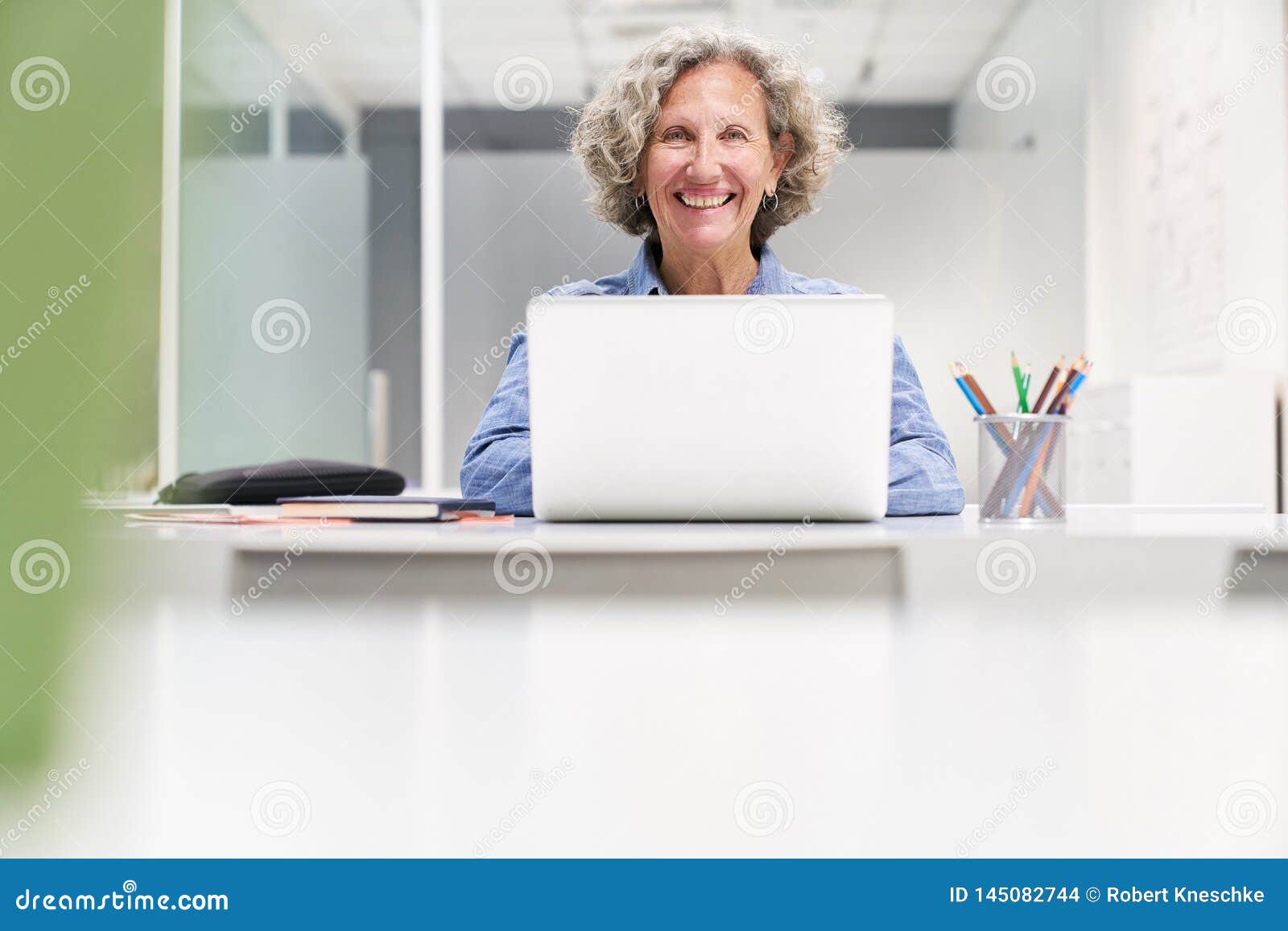Senior Woman Using Laptop Computer in Co-Working Space Stock Photo ...