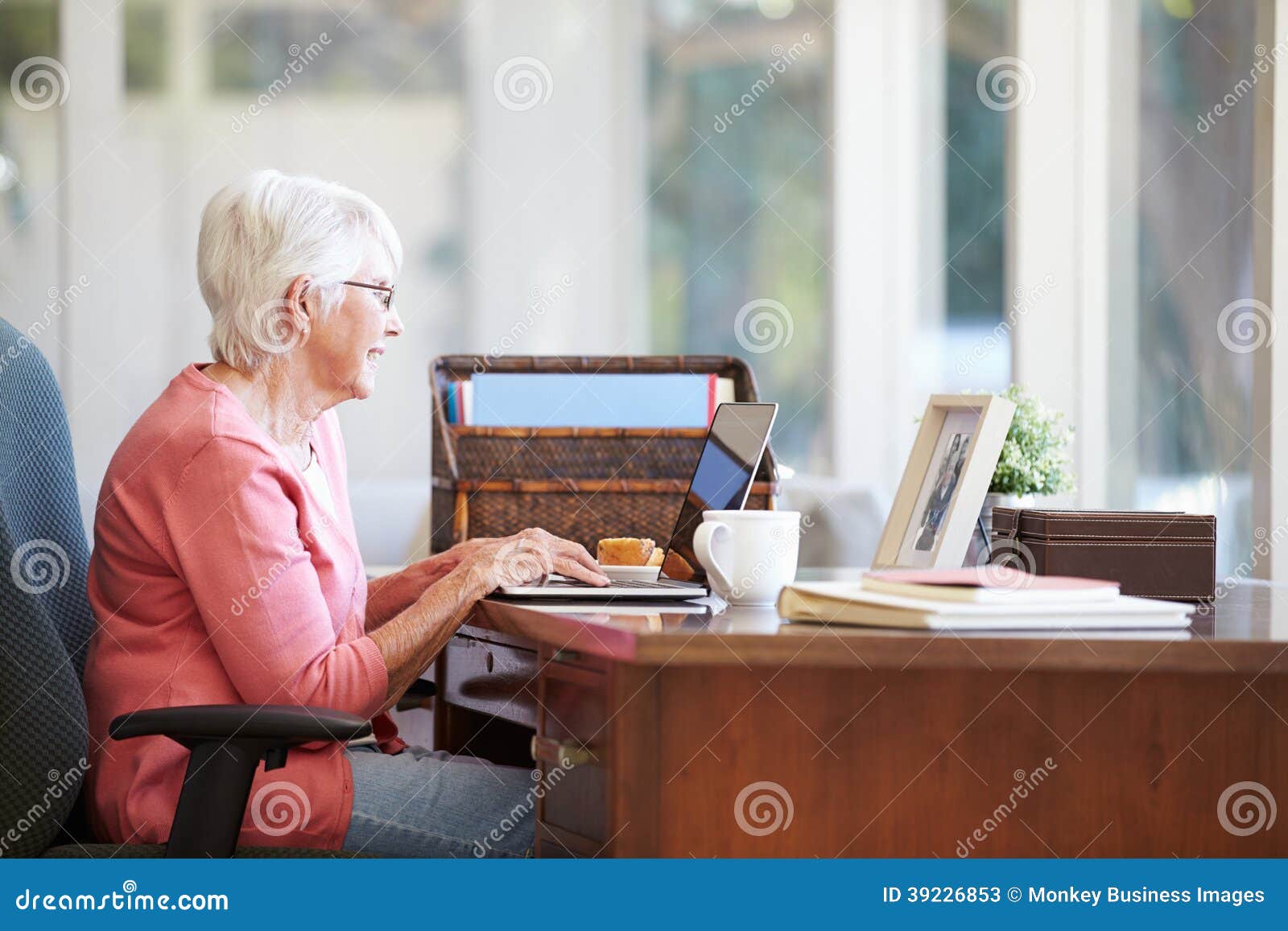Senior Woman Using Laptop on Desk at Home Stock Image - Image of ...