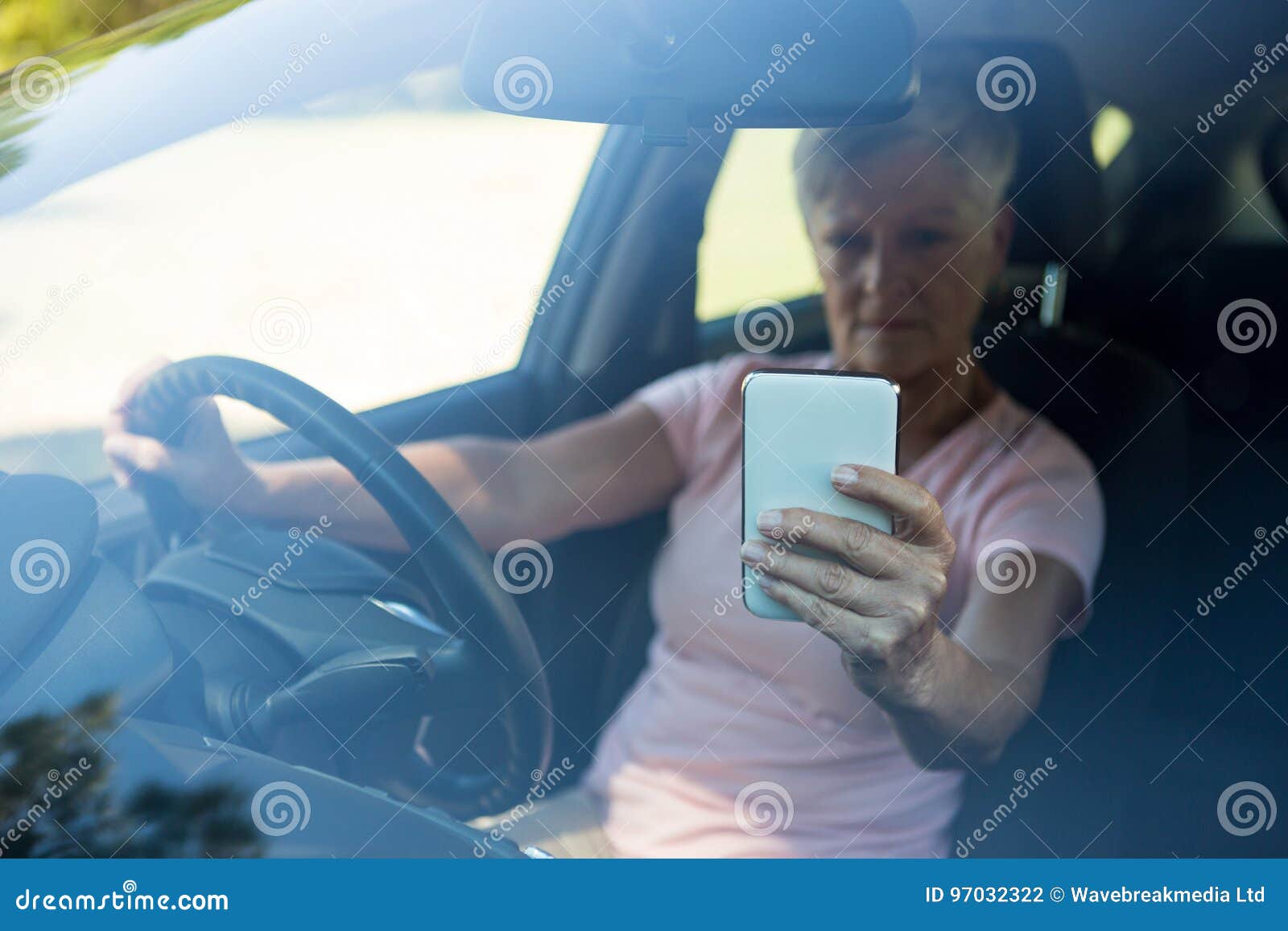 Senior Woman Using Mobile Phone while Driving Car Stock Photo - Image ...