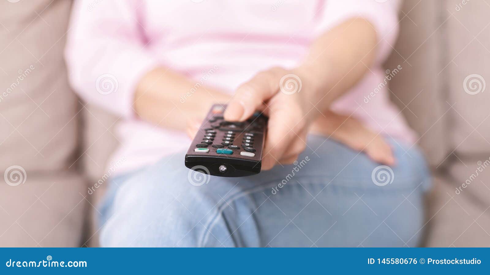 Senior Woman Using TV Remote Control on Sofa at Home Stock Photo ...