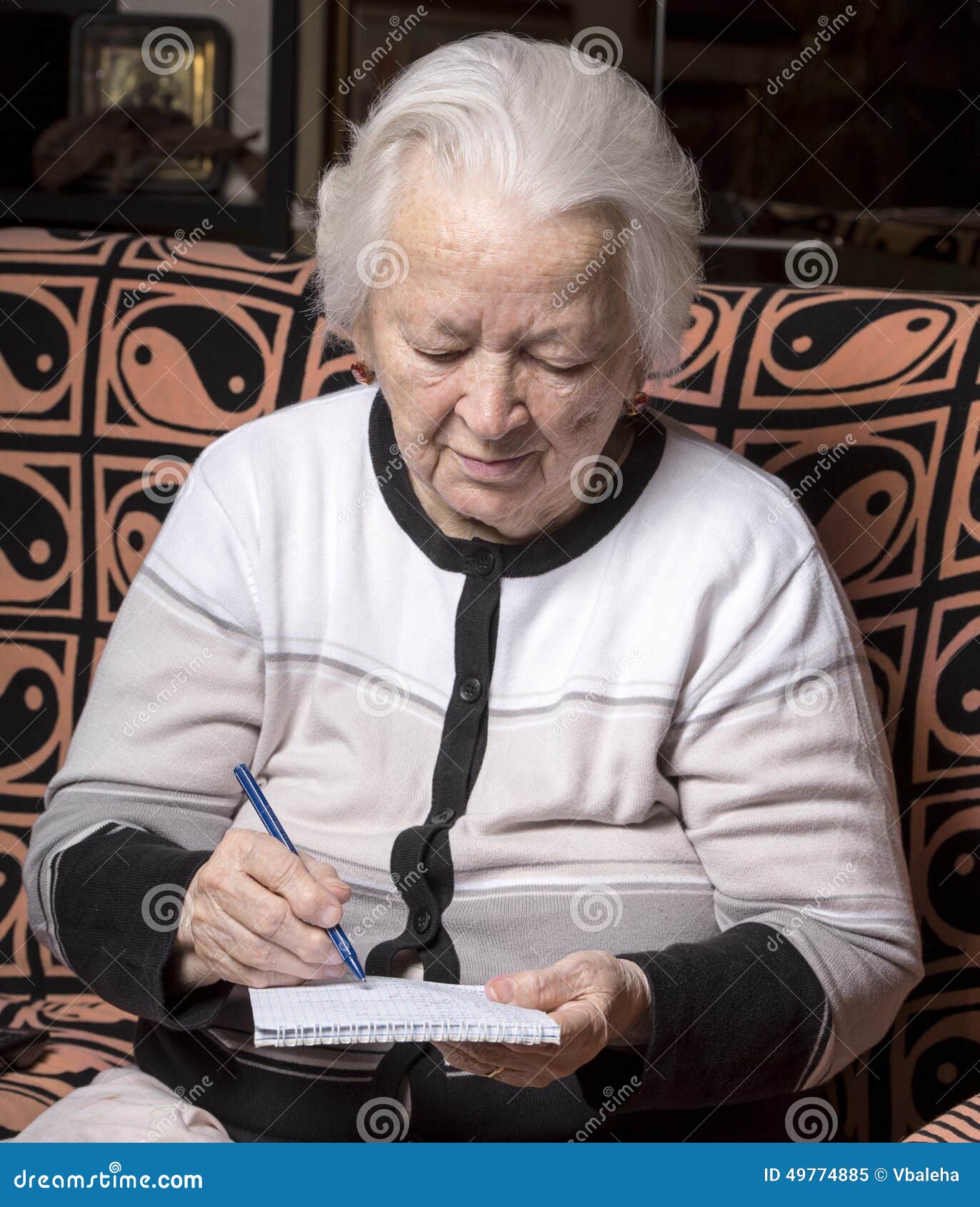 Senior woman writing notes stock image. Image of indoors - 49774885