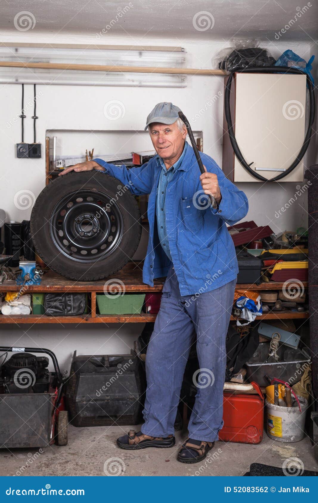 Senior Worker with a Tire in Garage Stock Photo - Image of people ...
