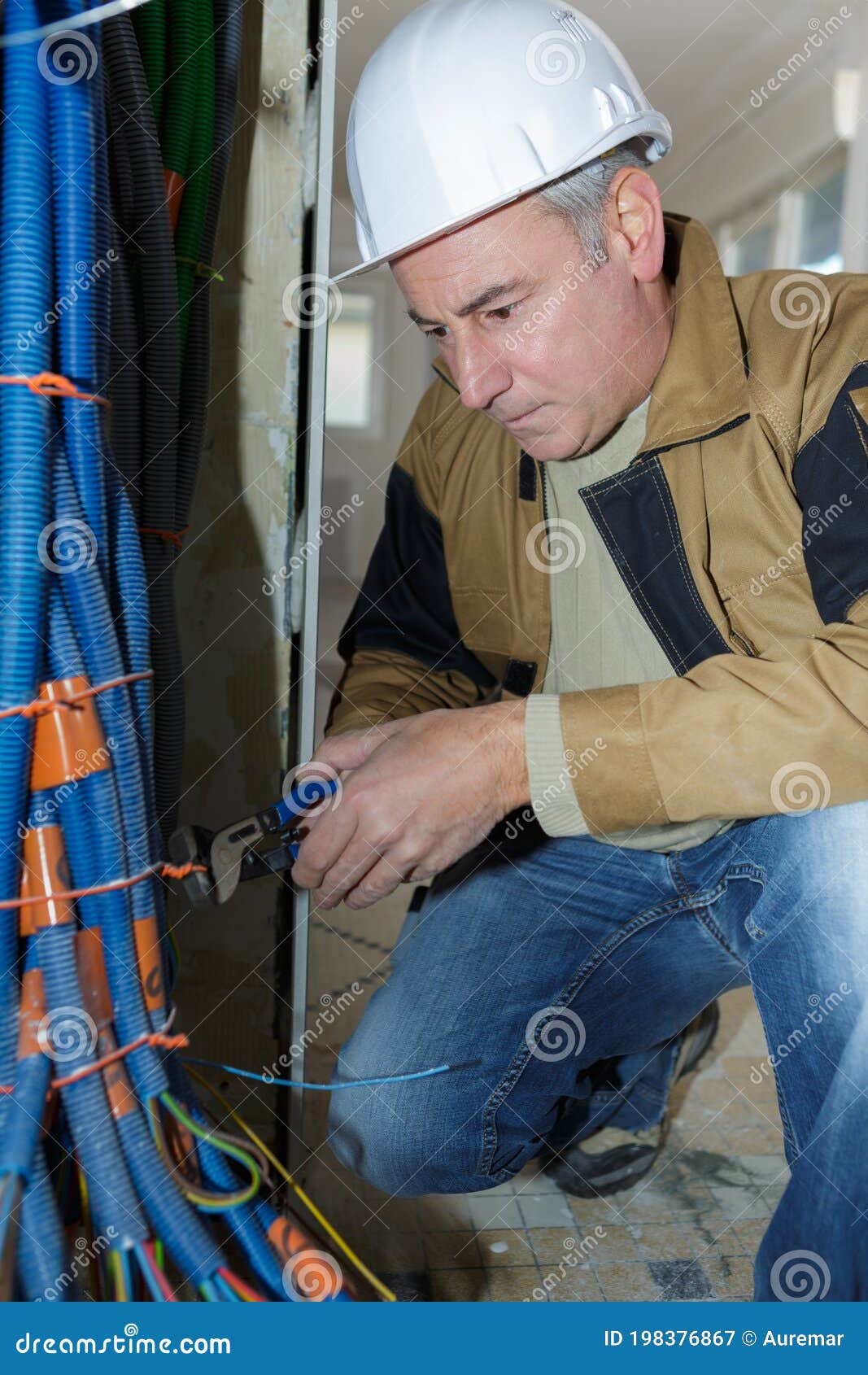 Senior Worker Twisting Tie Around Bundle Cable Trunking Stock Image ...