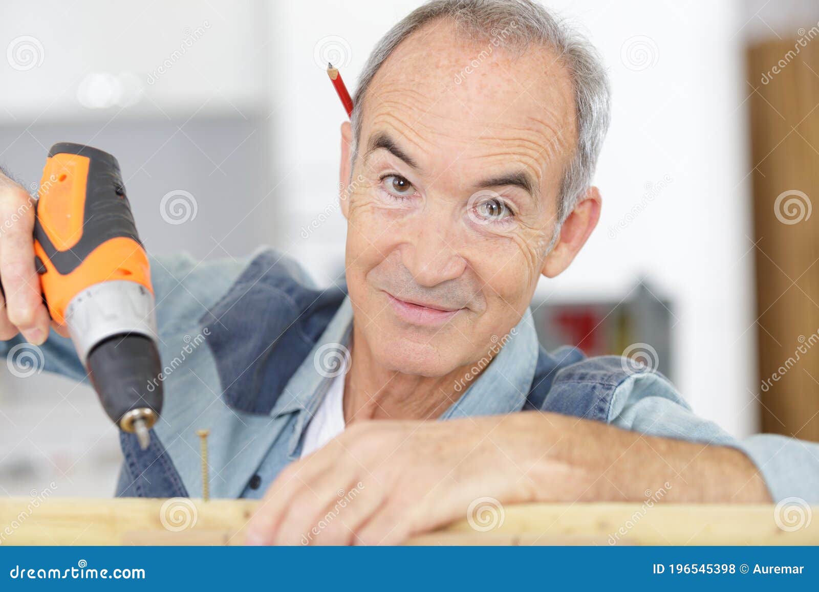 Senior Worker Using Drill at Construction Site Stock Photo - Image of ...