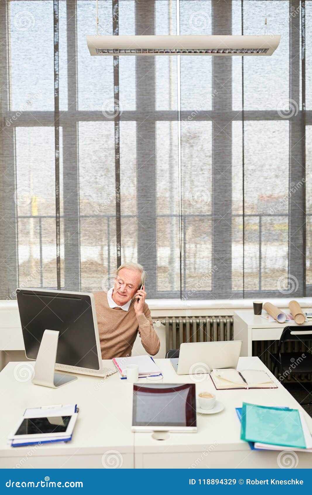 Senior Working with Computer and Making a Call Stock Image - Image of ...