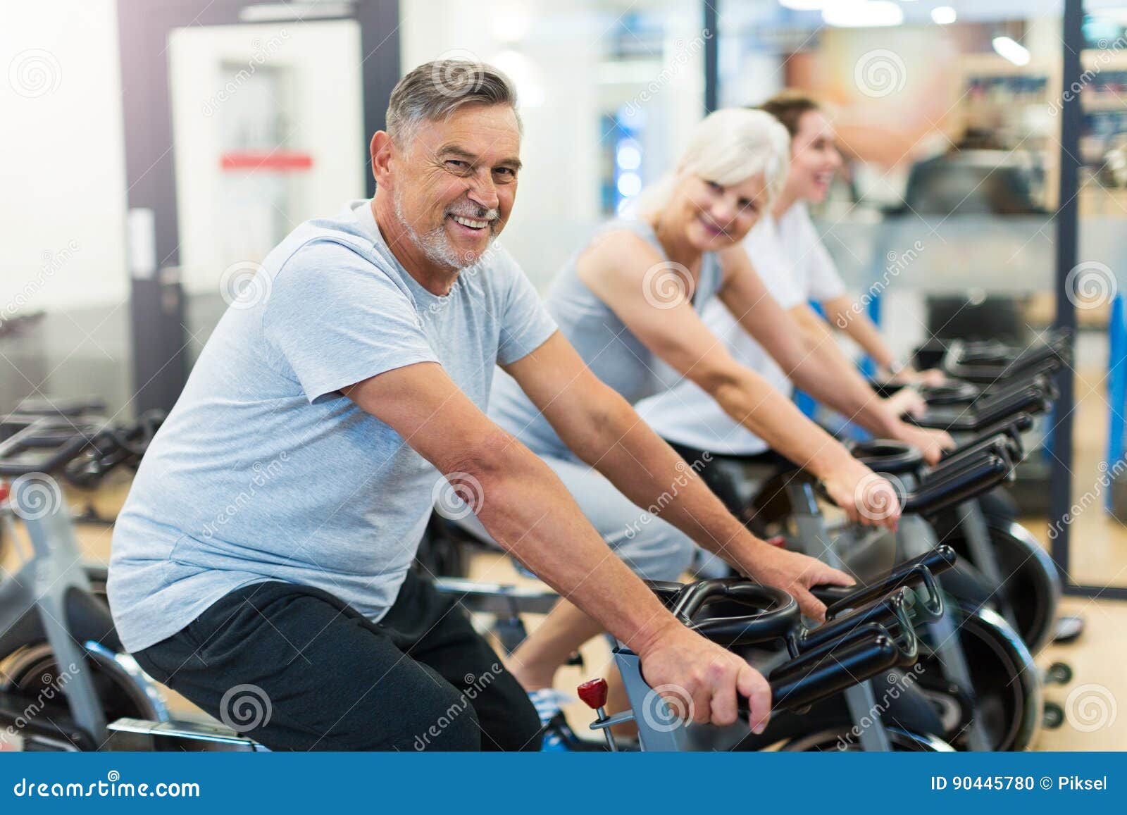 Seniors on Exercise Bikes in Spinning Class at Gym Stock Photo - Image ...
