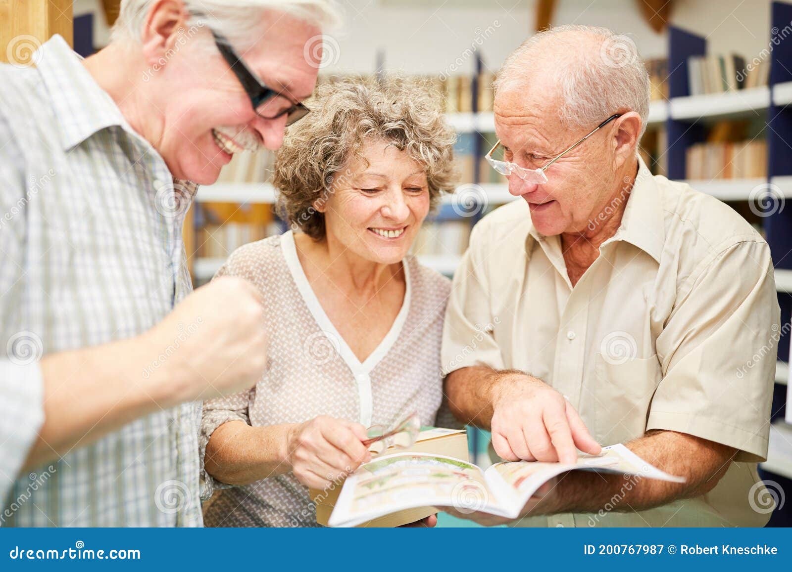 Seniors in the Library with a Book Stock Image - Image of people ...