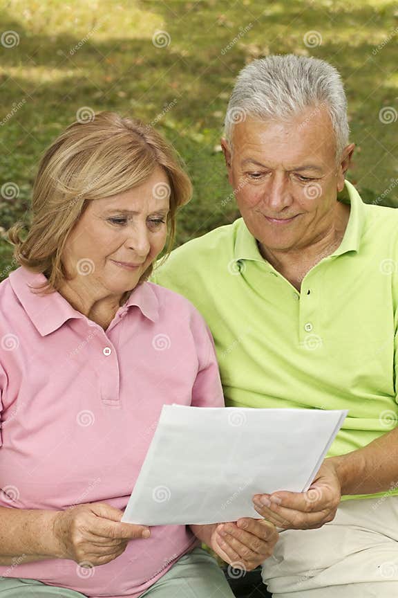 Seniors read paper stock photo. Image of woman, paper - 28794060