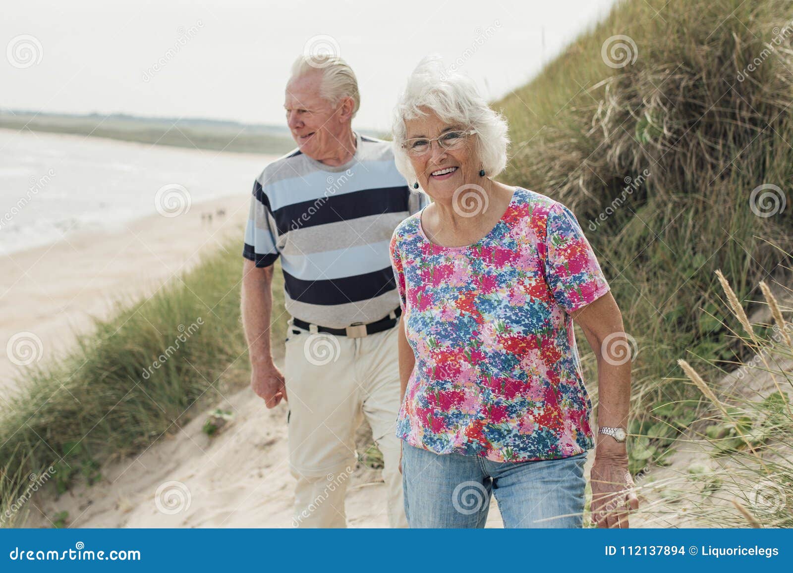 Seniors Relaxing at the Beach Stock Photo - Image of seniors, sand ...