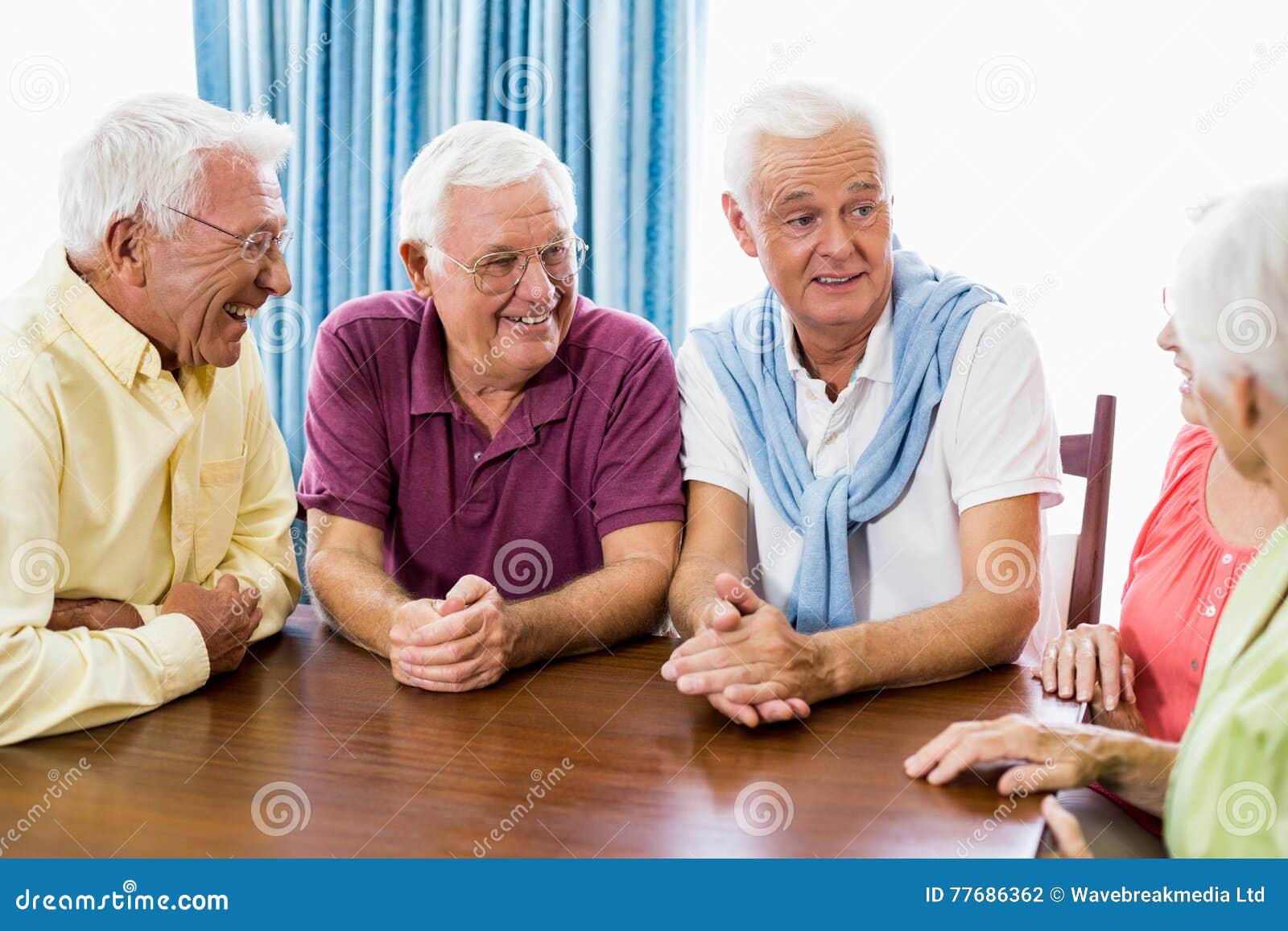 Seniors talking at table stock photo. Image of friendship - 77686362