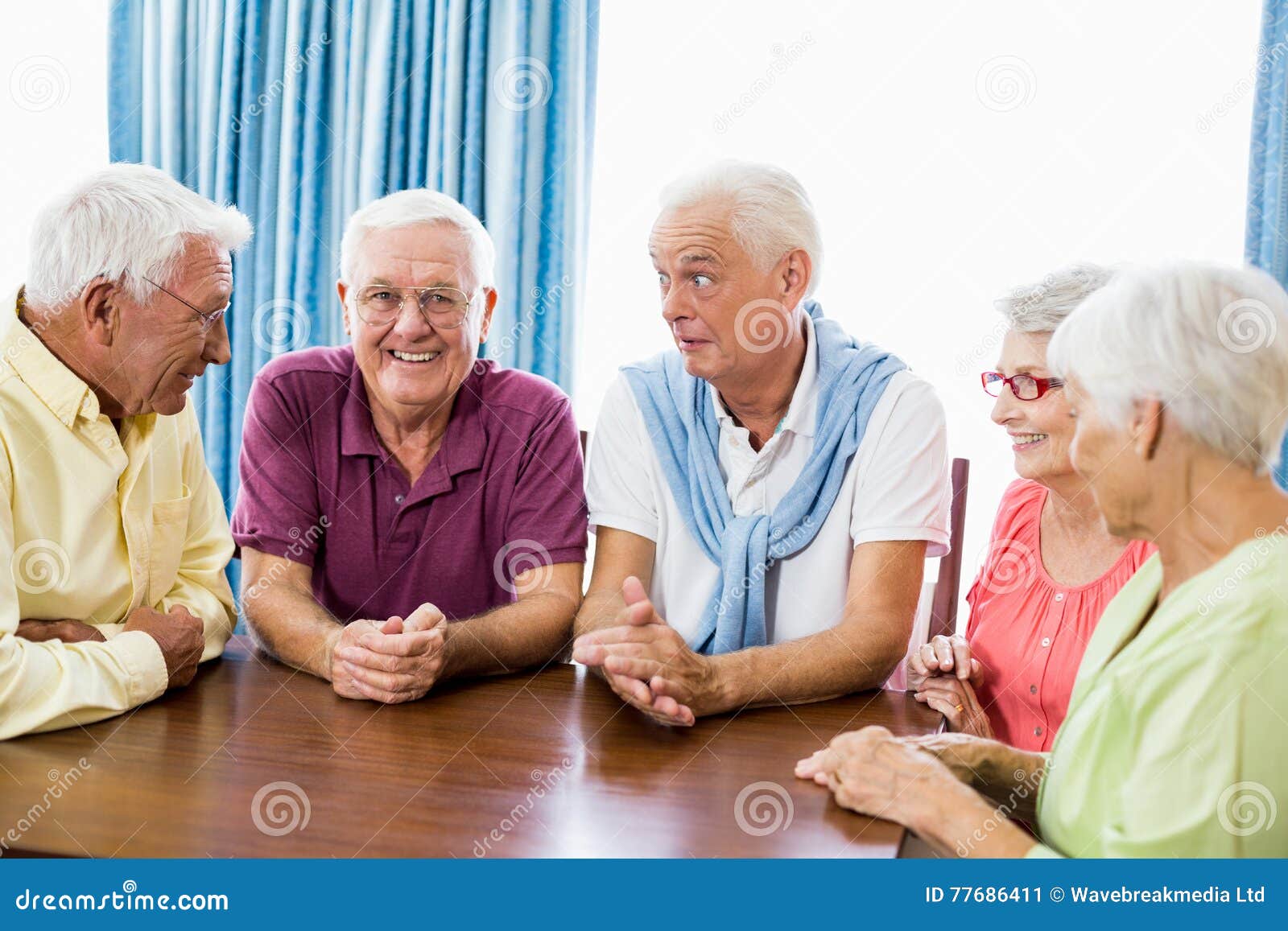 Seniors talking at table stock image. Image of citizen - 77686411