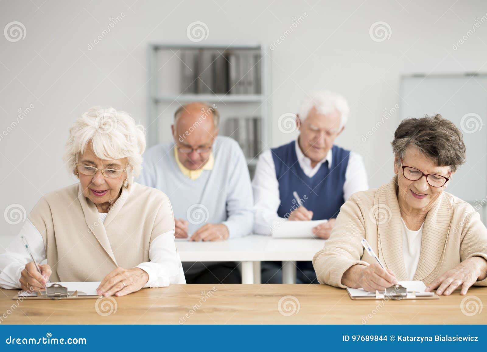 Seniors writing test stock photo. Image of desk, retired - 97689844