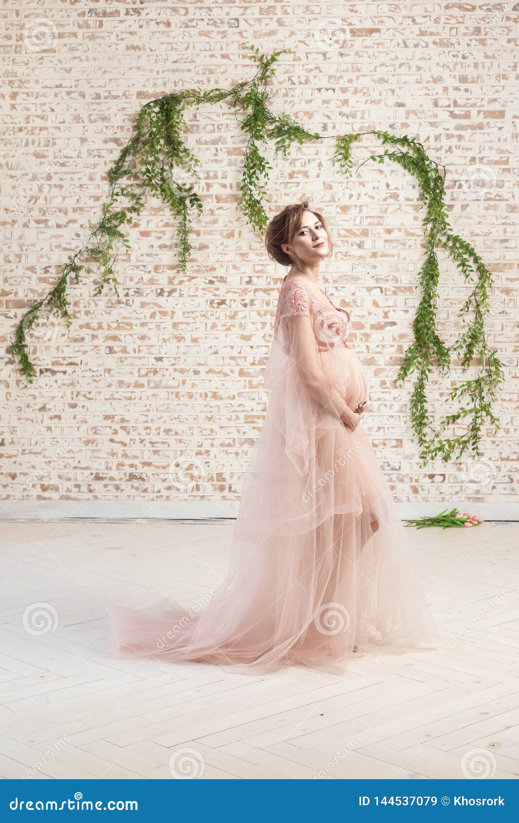Sensual Cheerful Beautiful Pregnant Young Woman In Pink Dress Standing