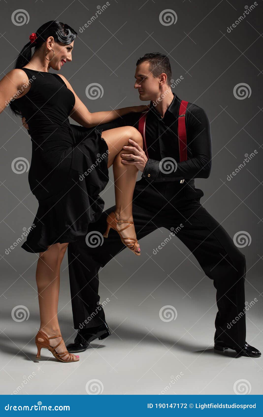 Dancer Touching Leg of Partner while Dancing Tango on Grey Background ...