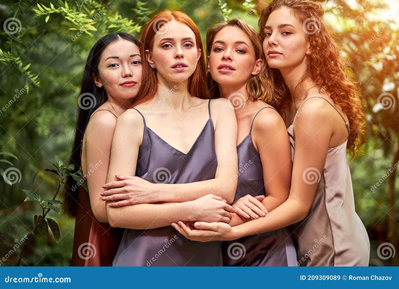 Group Of Friendly Sensual Ladies In Elegant Silk Dress Posing Among