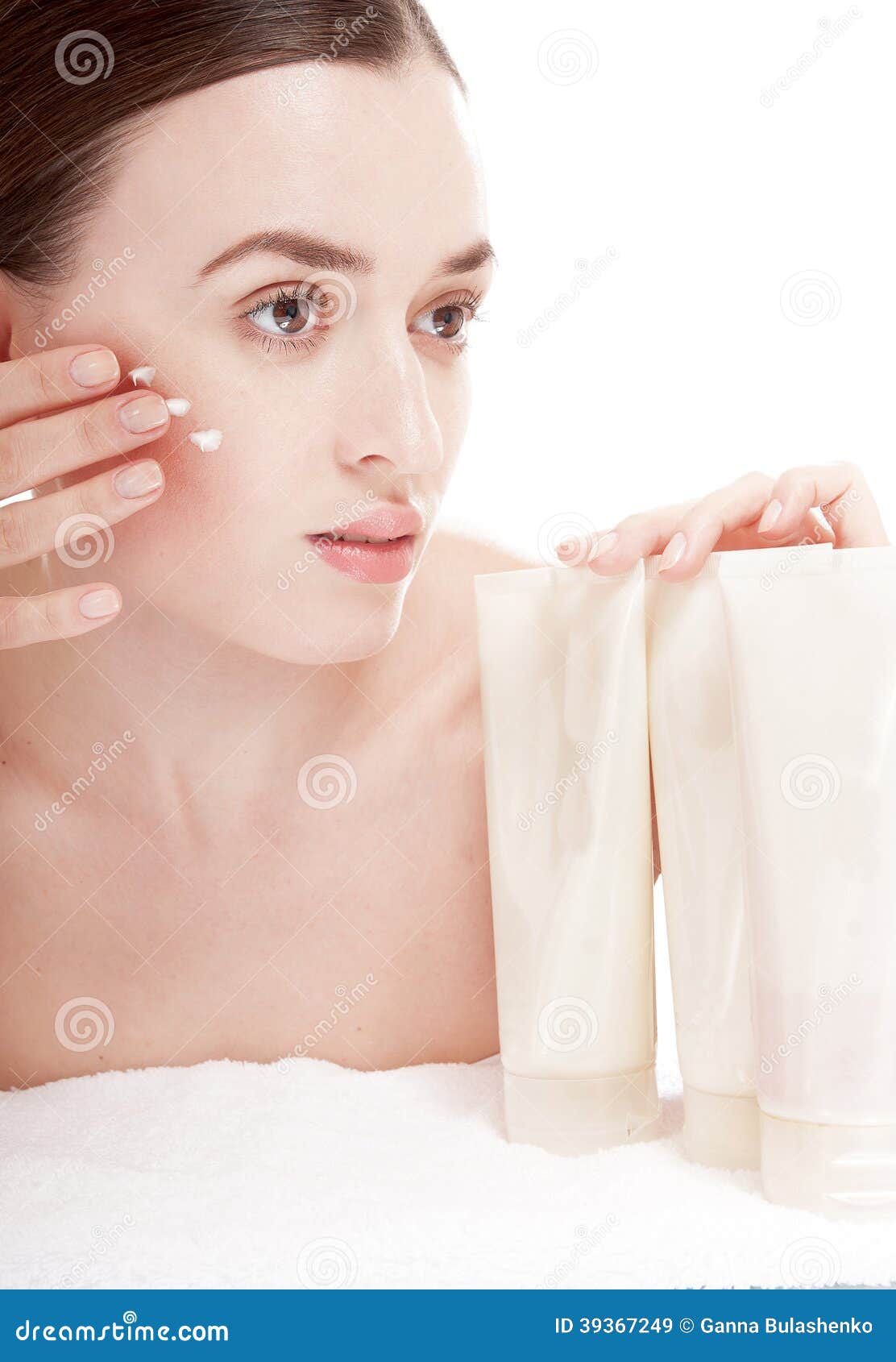 Sensual Woman Applying Cosmetic Cream Treatment On Her Face Stock
