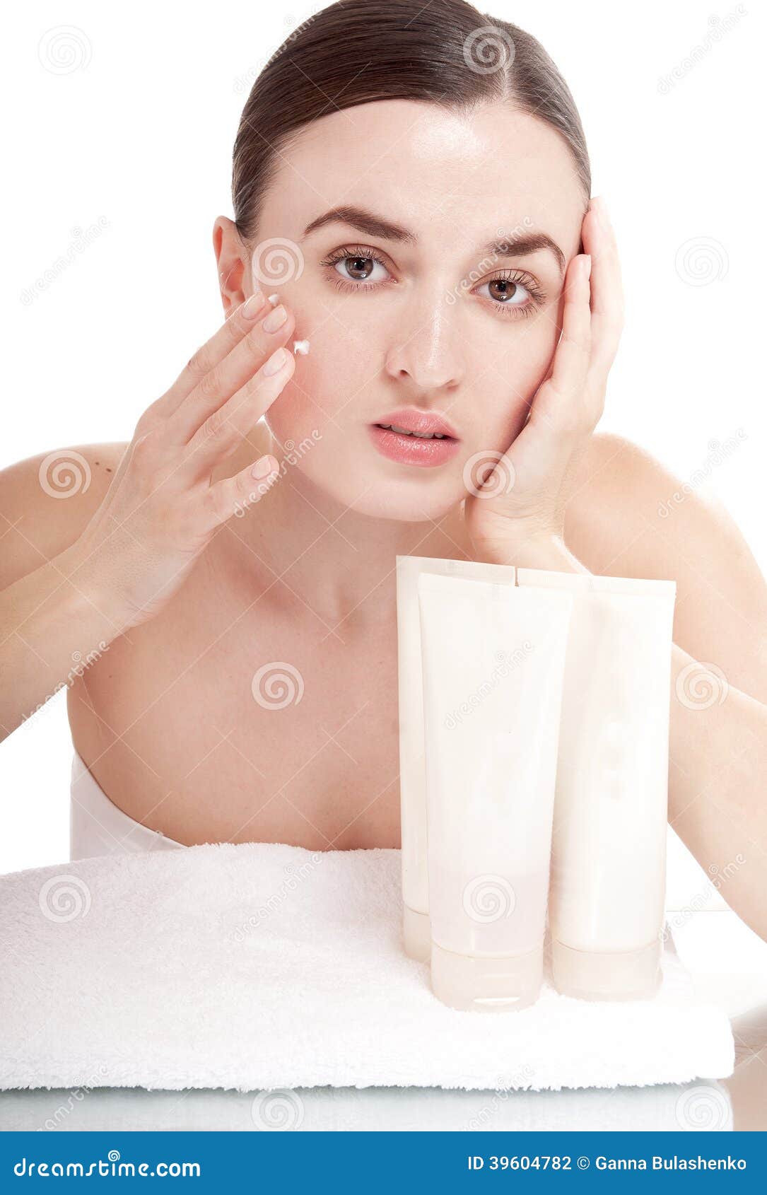 Sensual Woman Applying Cosmetic Cream Treatment On Her Face Stock