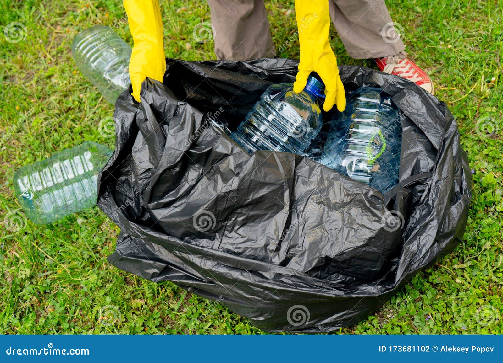 Hands in Yellow Gloves Putting Big Plastic Bottles into Bllack Plastic ...