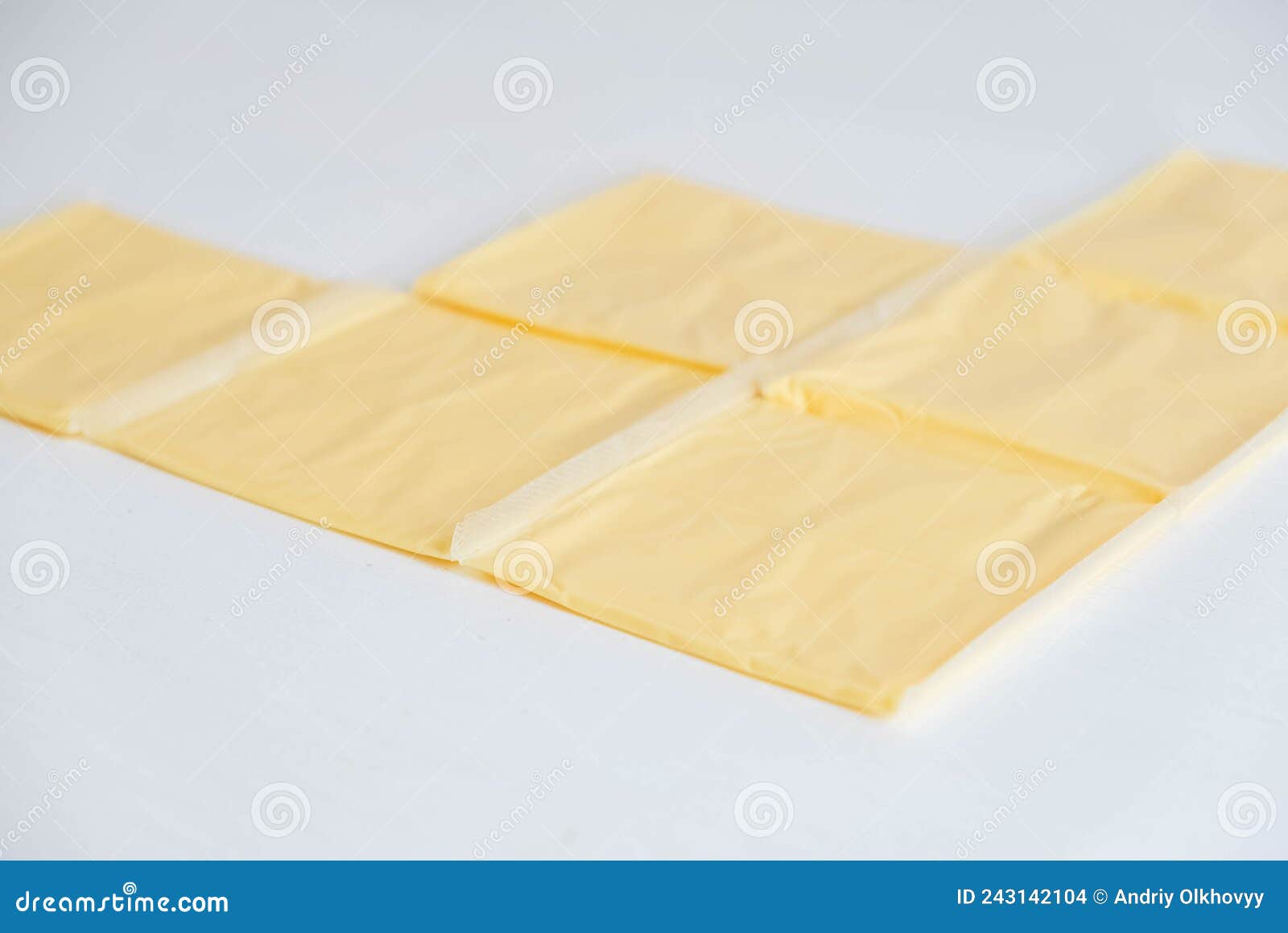 Separately Packed Cheese Slices on a White Wooden Table Background ...