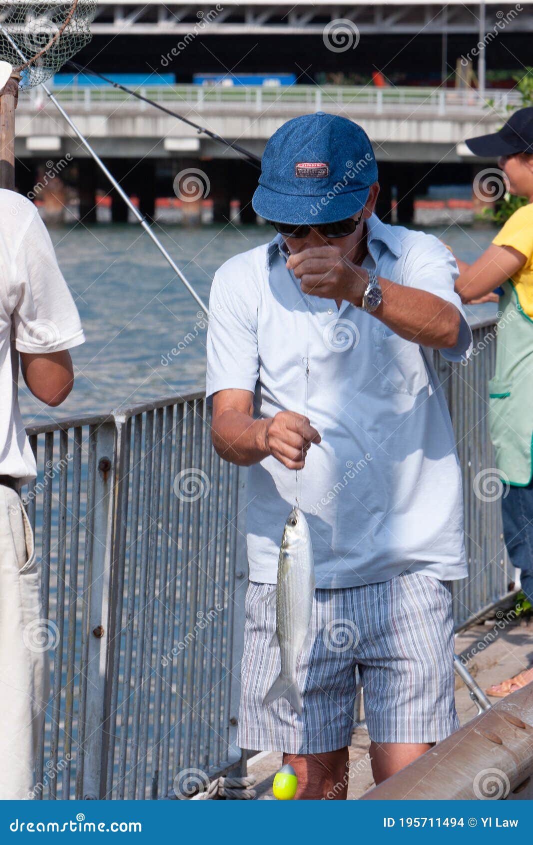 1 Sept 2007 the Old Man Releasing Fish while Standing at Shore ...