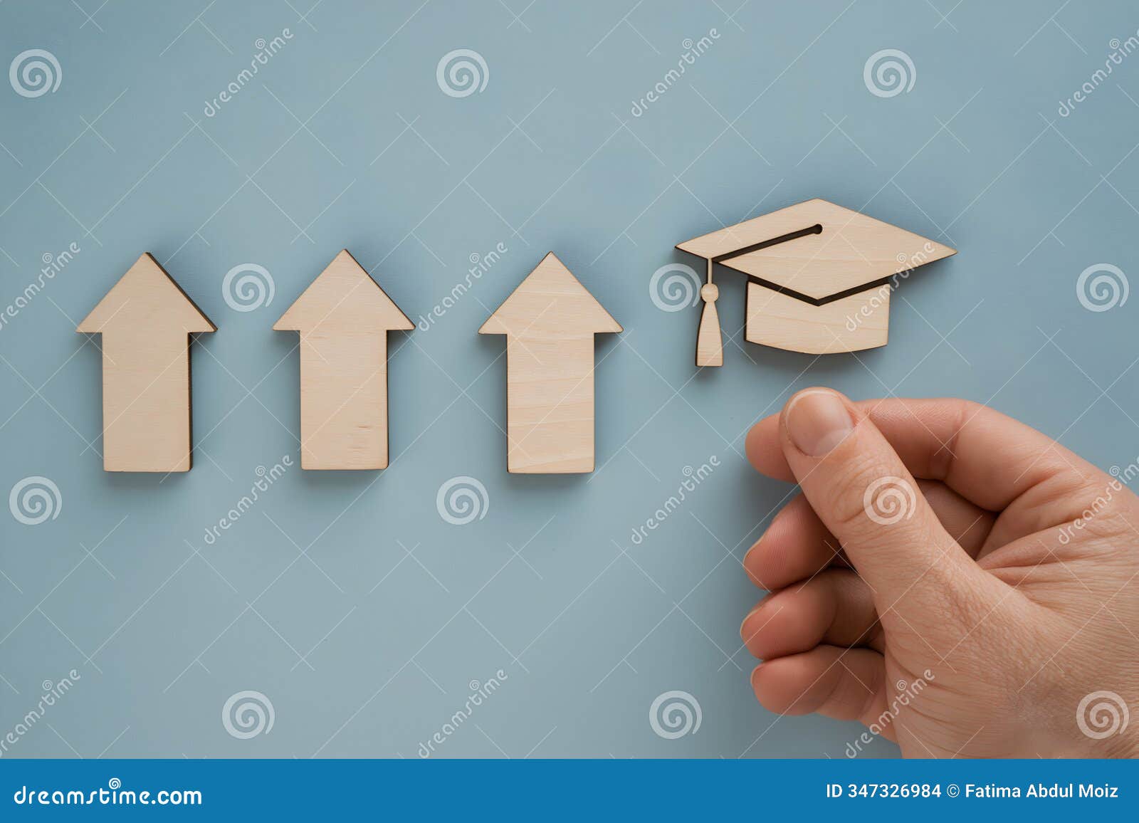 Sequence of Three Wooden Cutouts, Graduation Cap Held by Human Hand ...