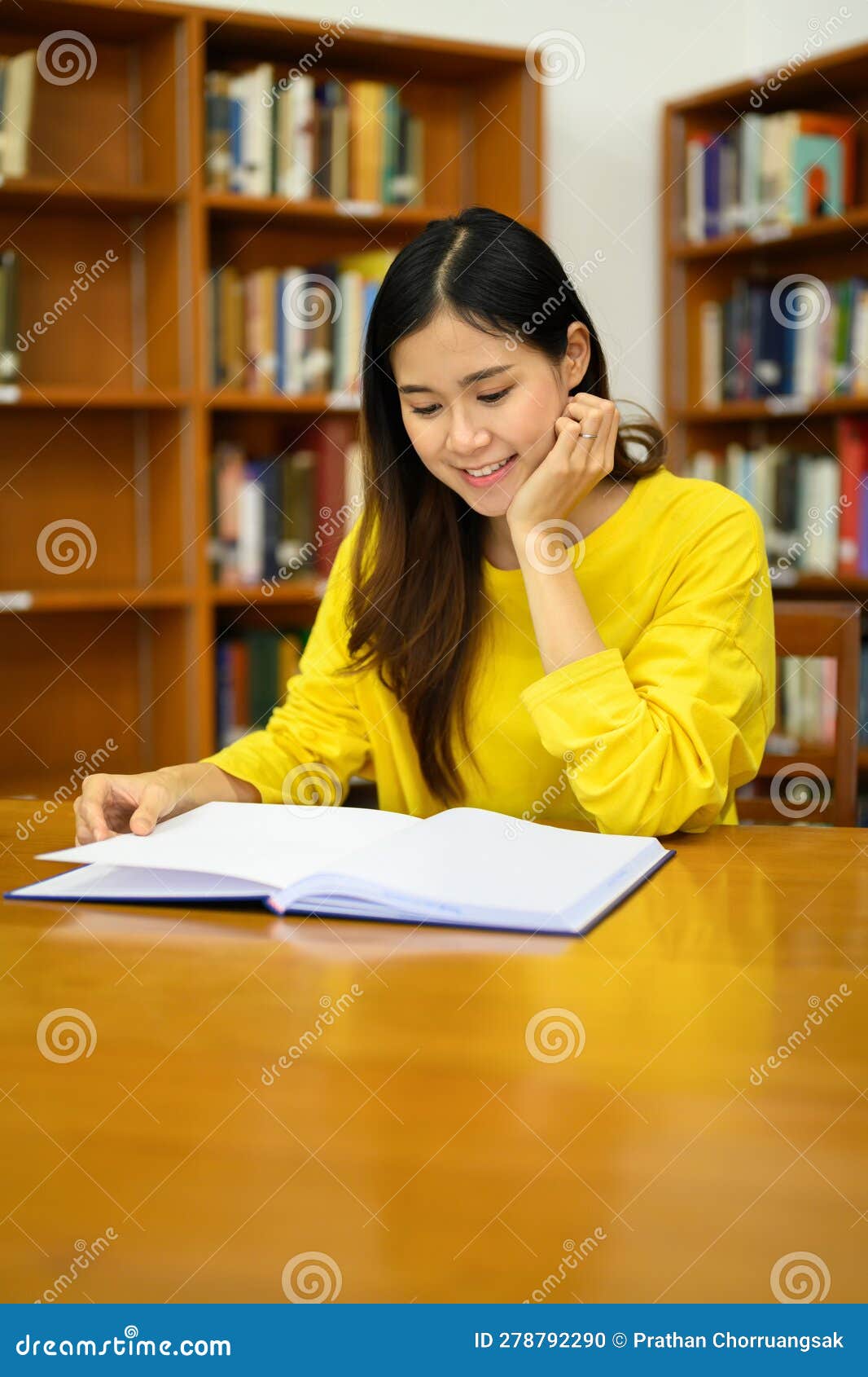 Serene Female Student Reading Book in a Library for Studying and ...
