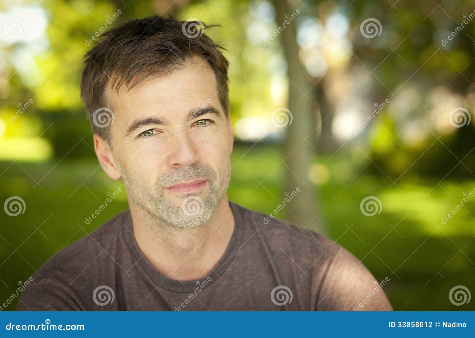 Serene Handsome Man Looking at the Camera Stock Photo - Image of green ...