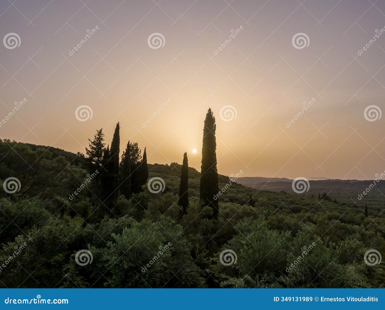 Serene Sunset Over a Tranquil Landscape with Silhouettes of Cypress ...