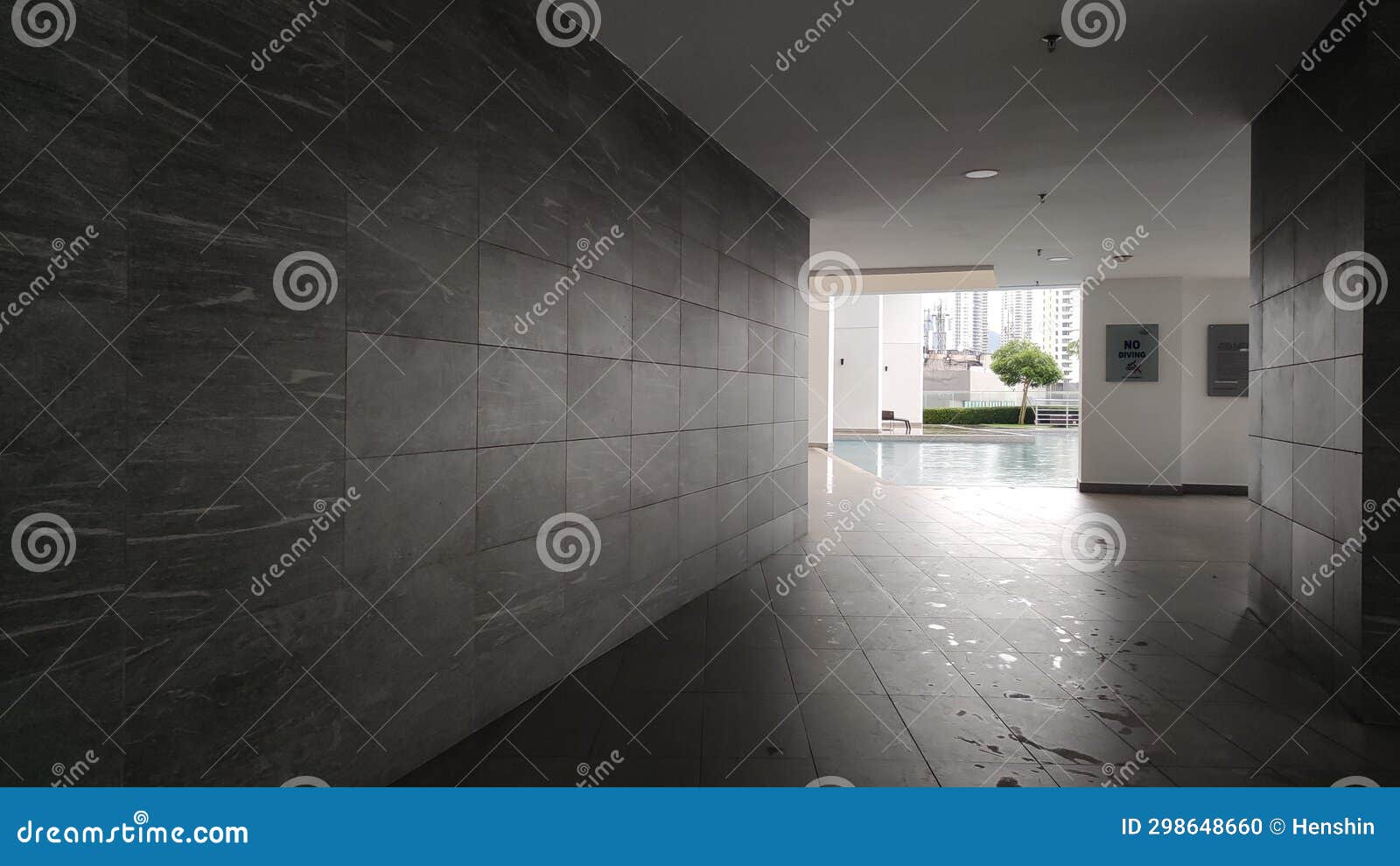 A Serene View of a Corridor with Concrete Tiles Pattern on the Wall ...